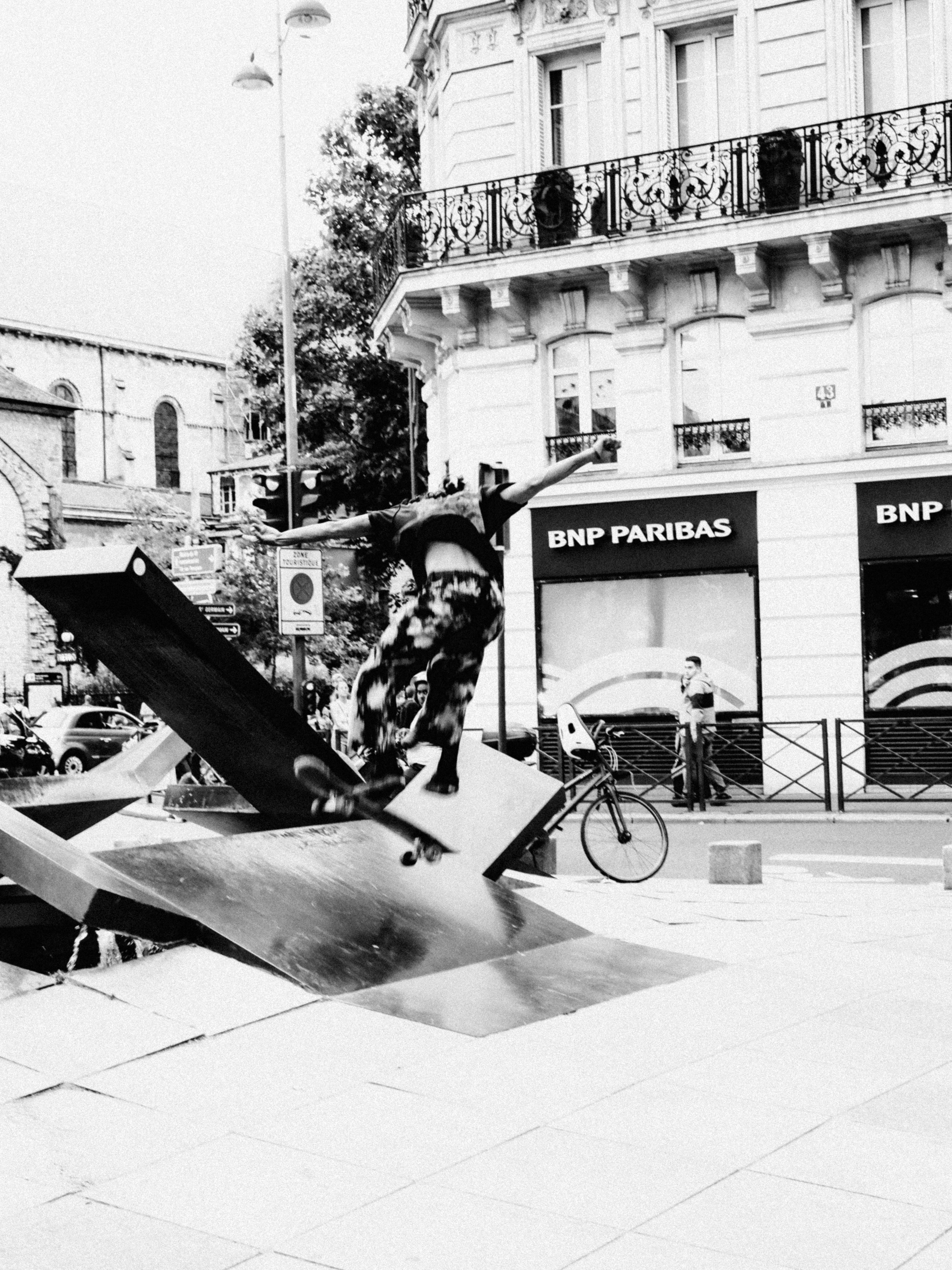 Urban Skateboarder Catches Air in a Black-and-White City Scene