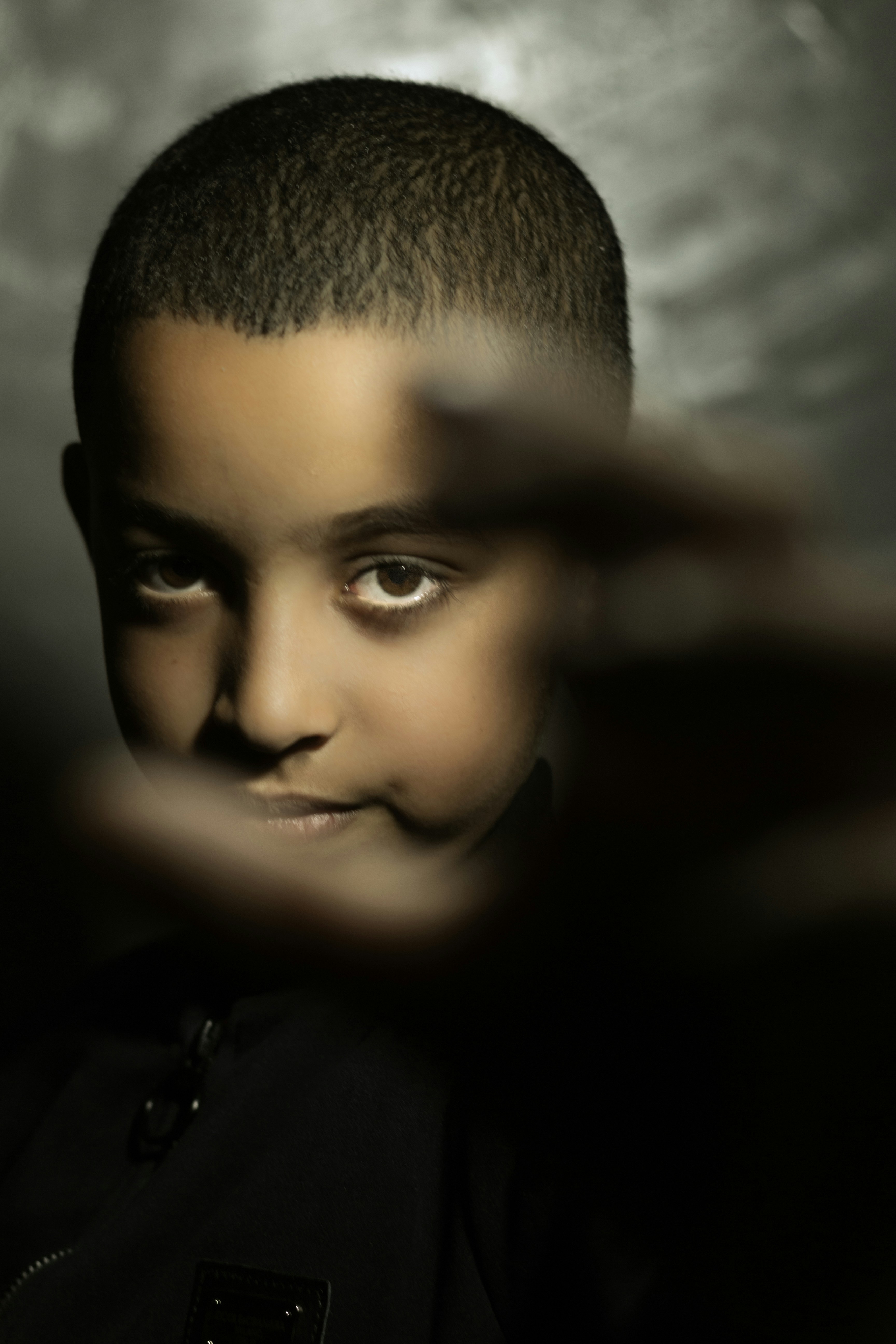 A young boy making a face with his hands photo – Free Portrait Image on ...