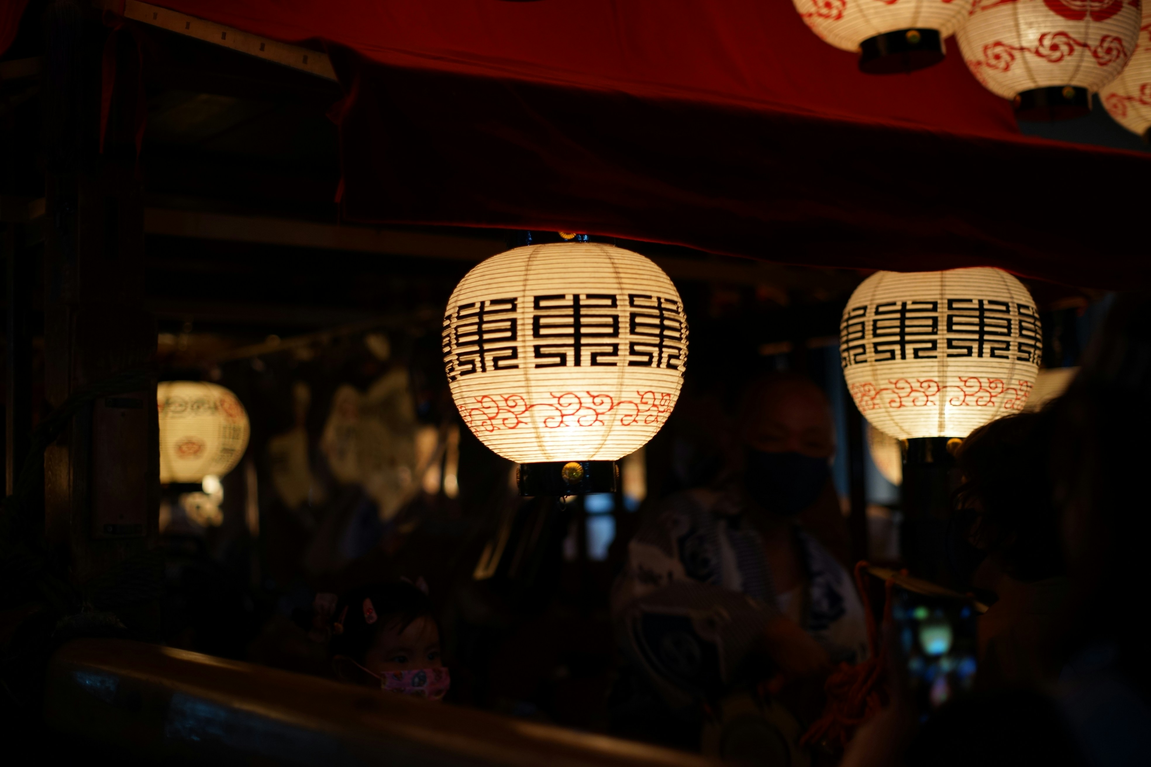 Lantern Glow Over a Dim Market: Night Festival in Motion