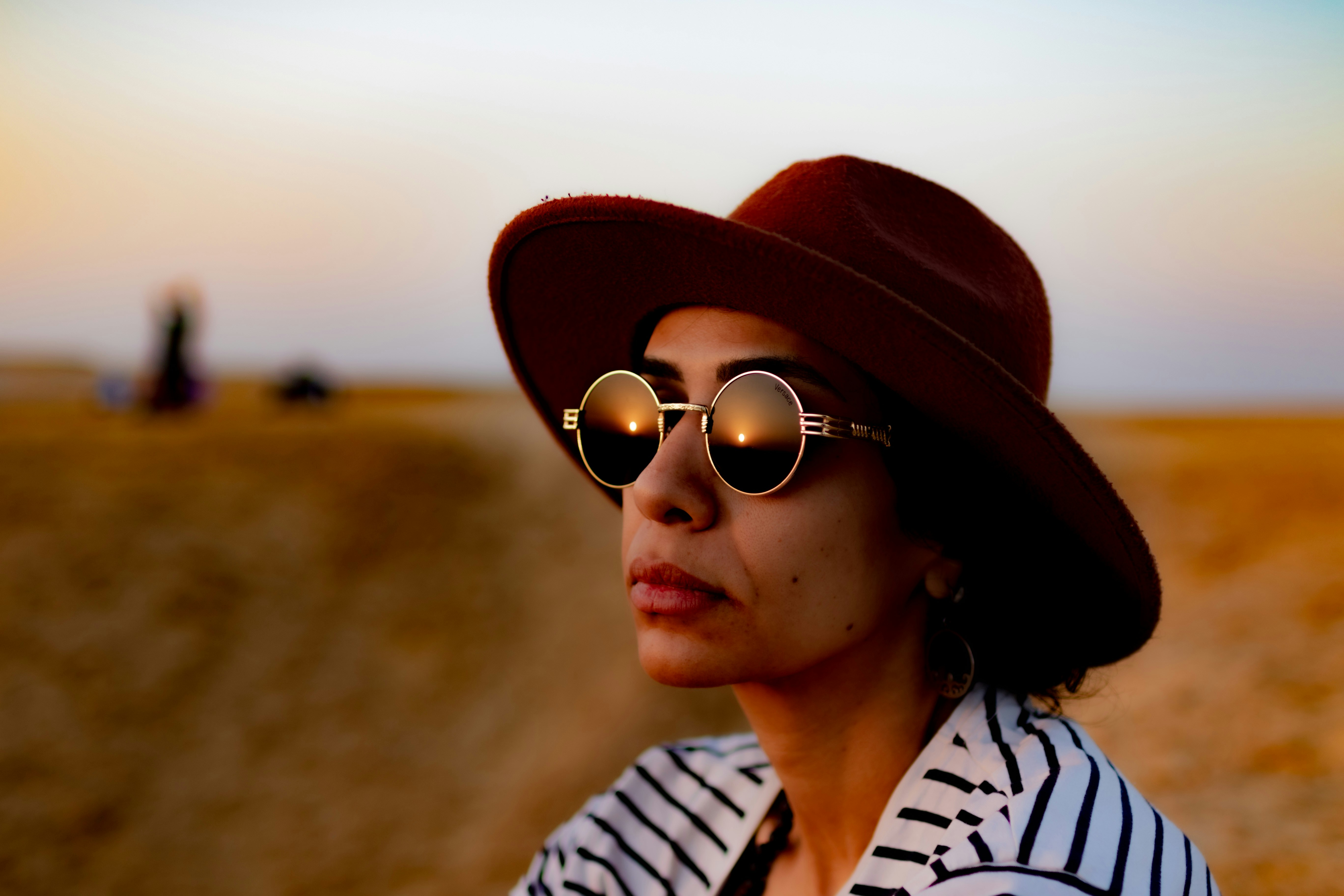 Burgundy Brim Portrait: Round Sunglasses at Dusk on the Shore
