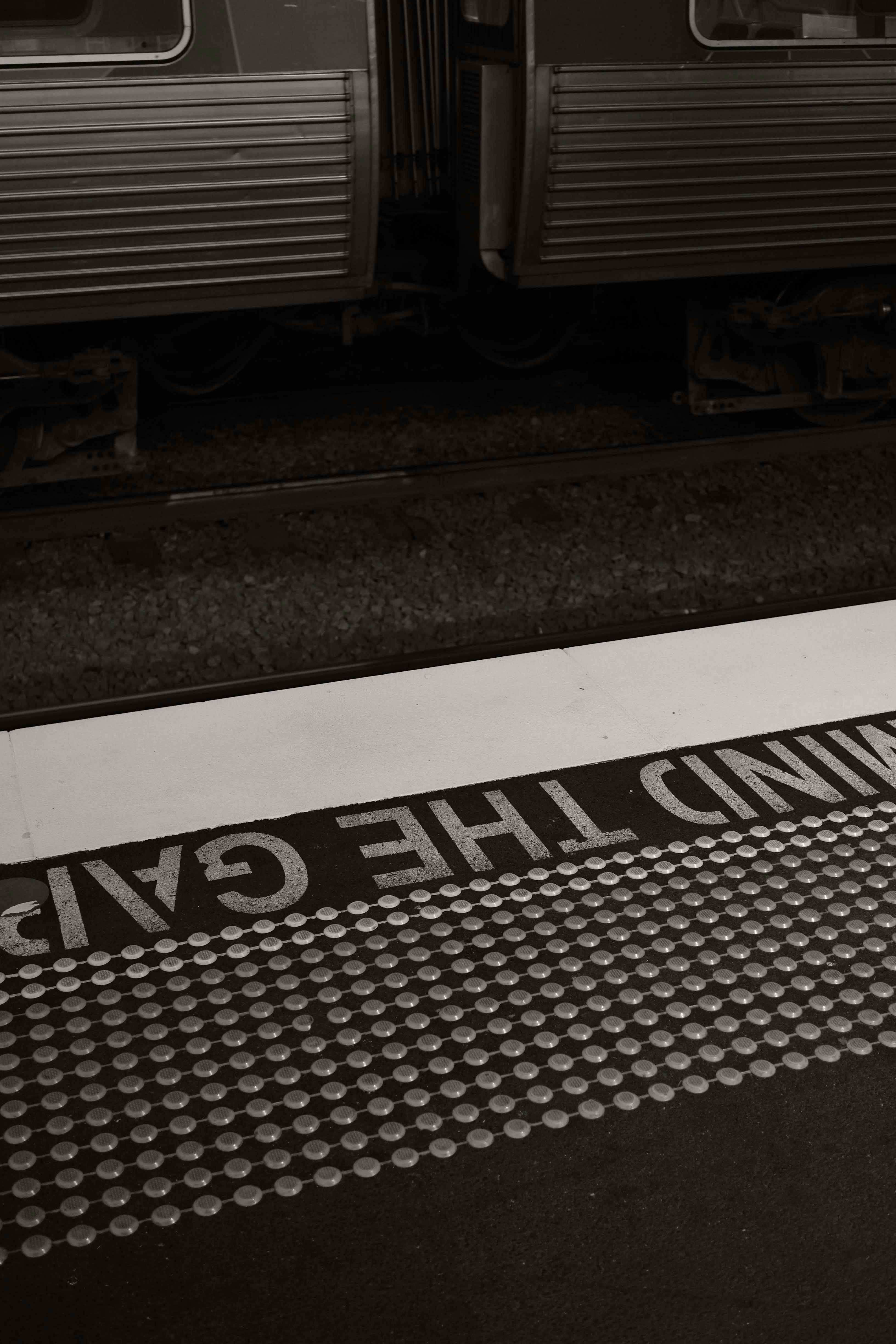 Platform Edge Quietly Framed: Trainside Shadows and Tactile Textures