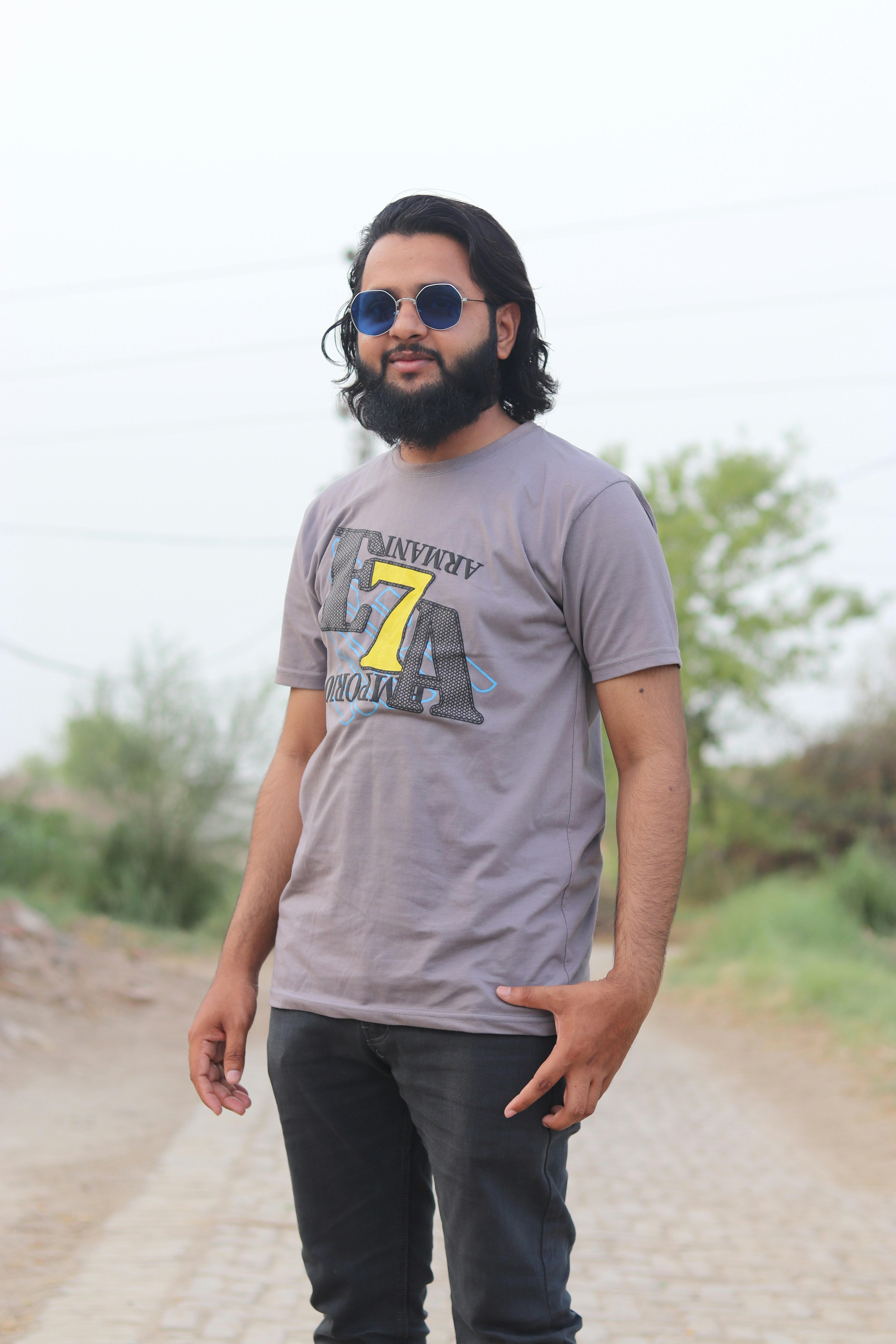 A man with a beard standing on a dirt road photo – Free Original photos ...