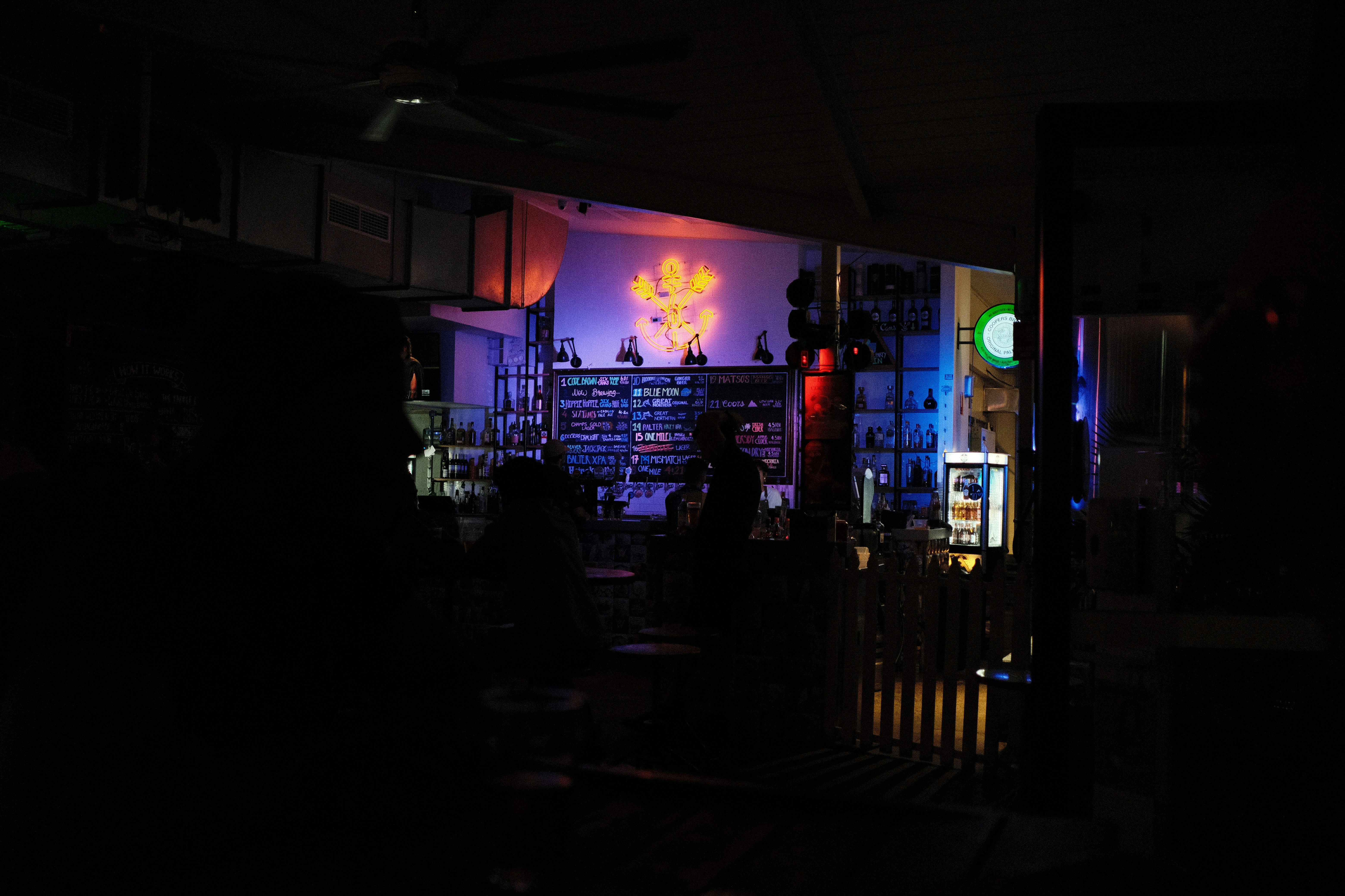  Neon-lit Bar Stage: Soft Glow Behind the Silhouettes