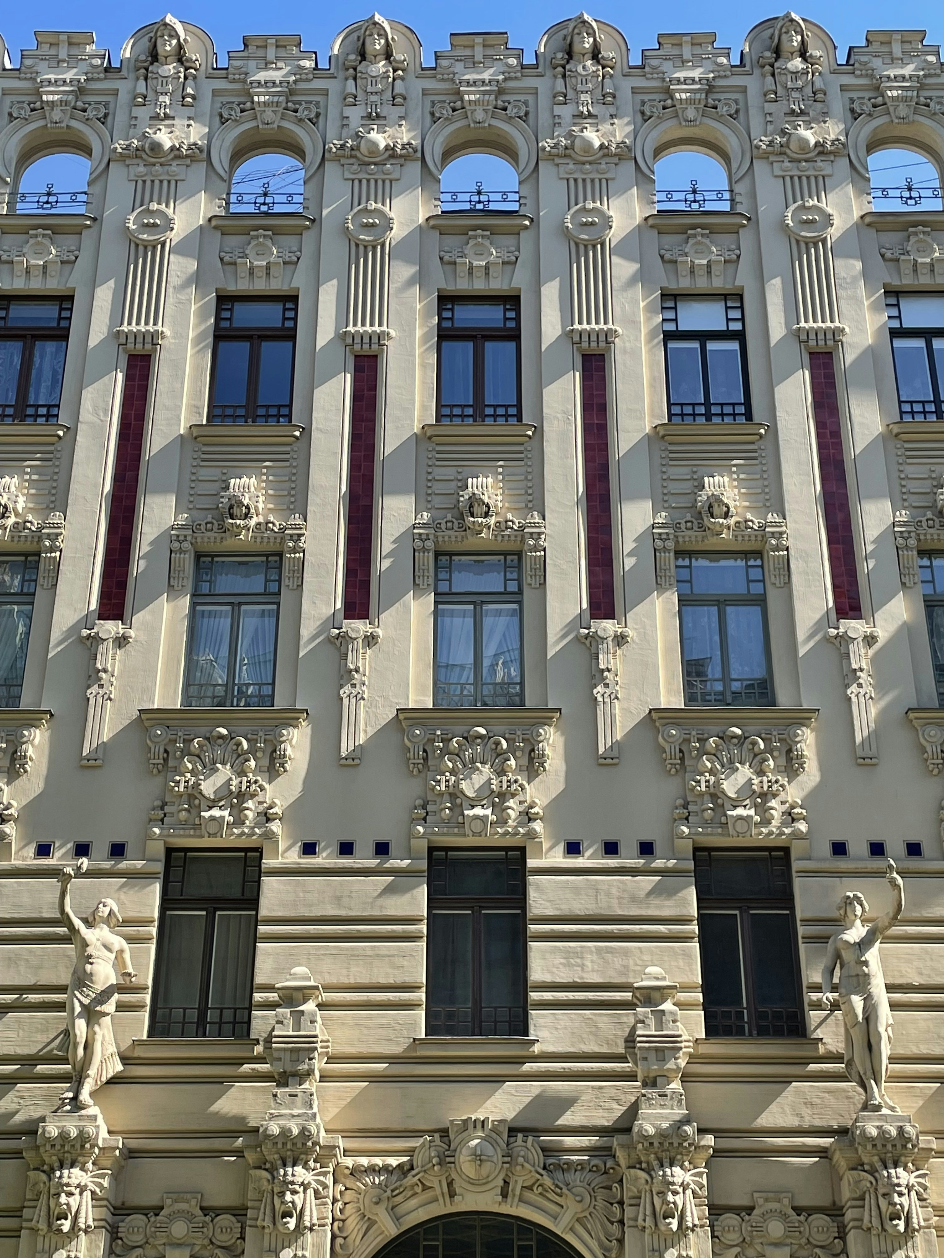 Symmetry in Stone: Arched Windows and Sculpted Facade of a Grand Building