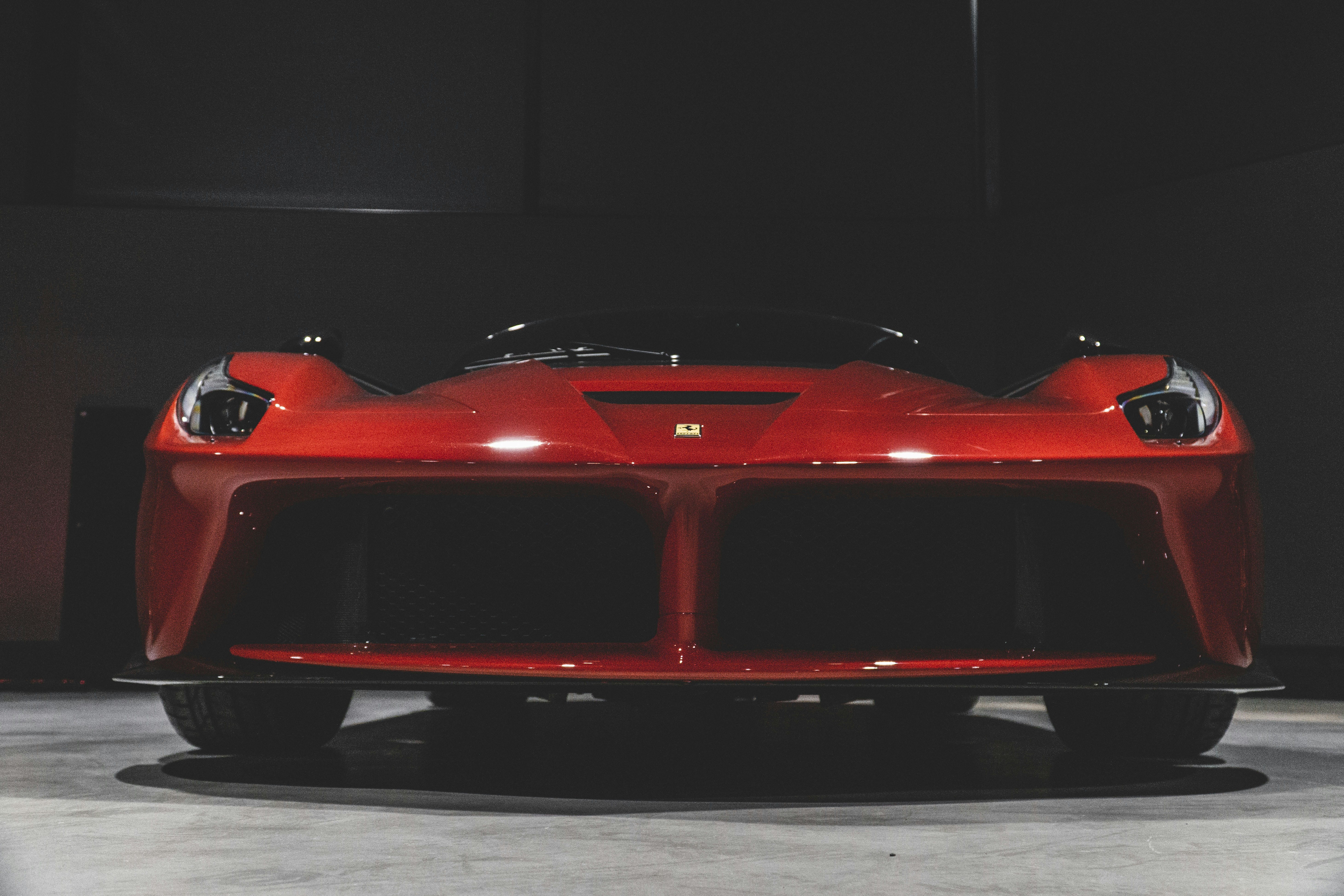 a red sports car parked in a garage