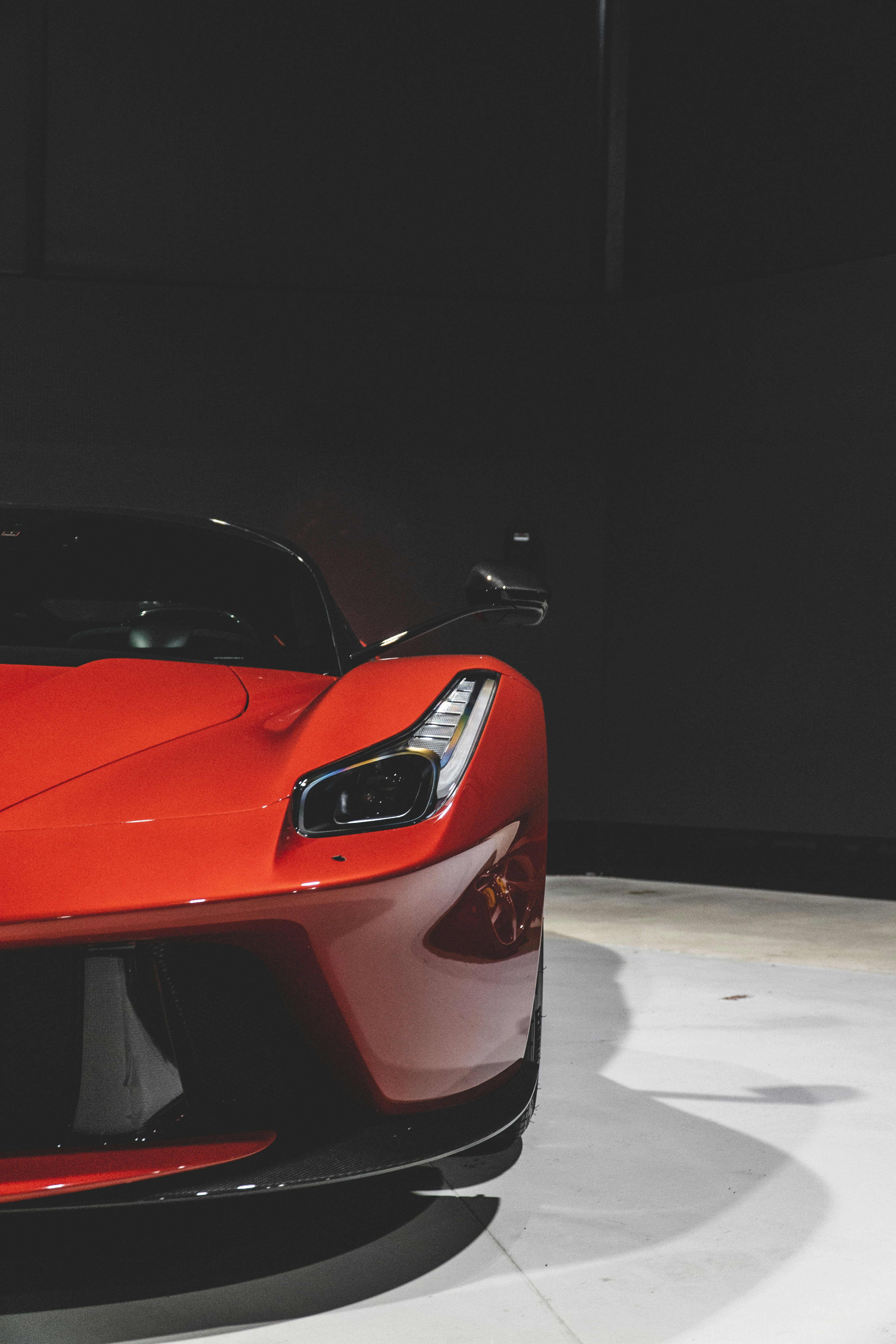 A red sports car is on display at a show photo – Free Ferrari Image on ...