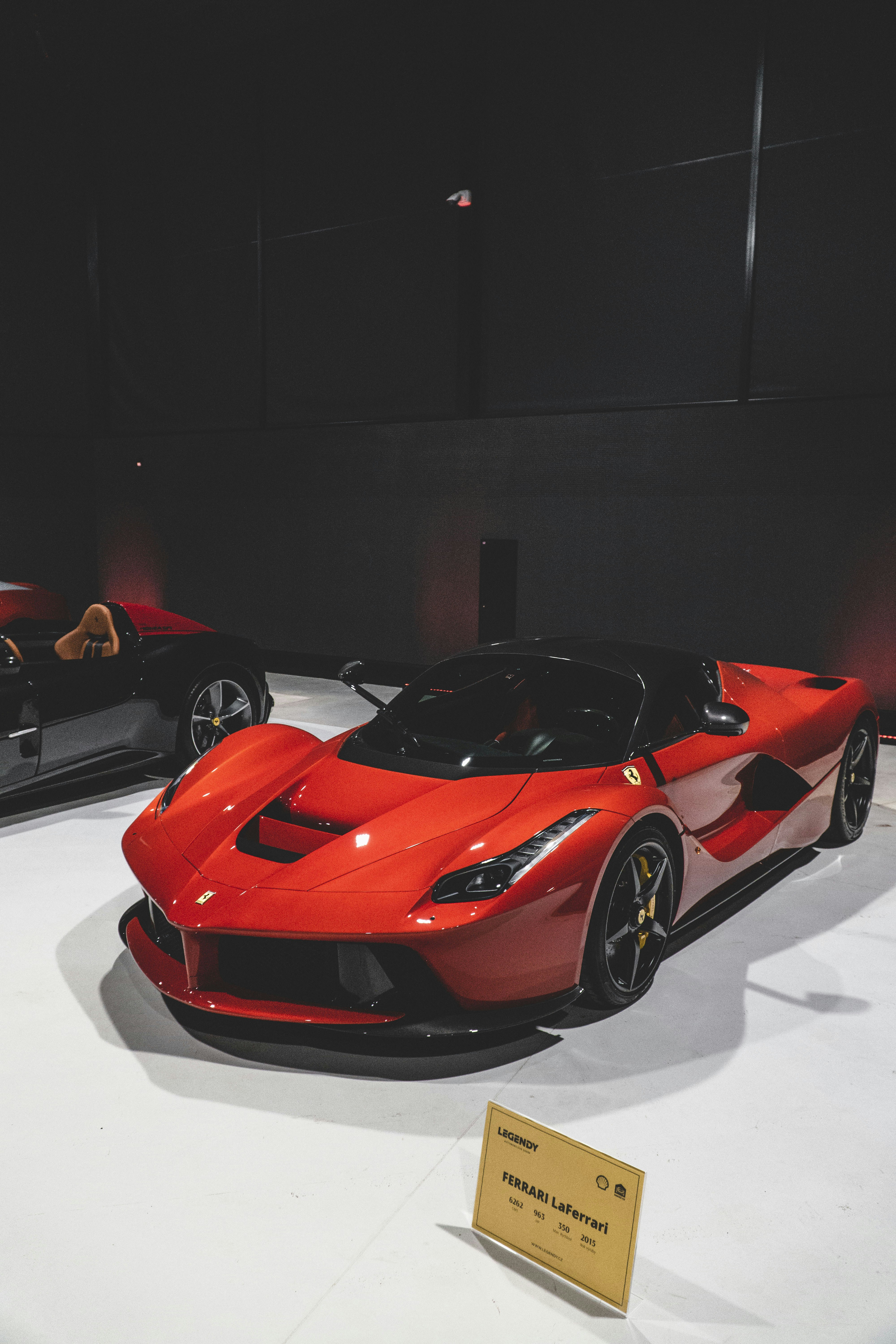 A red and black sports car on display photo – Free Ferrari Image on ...