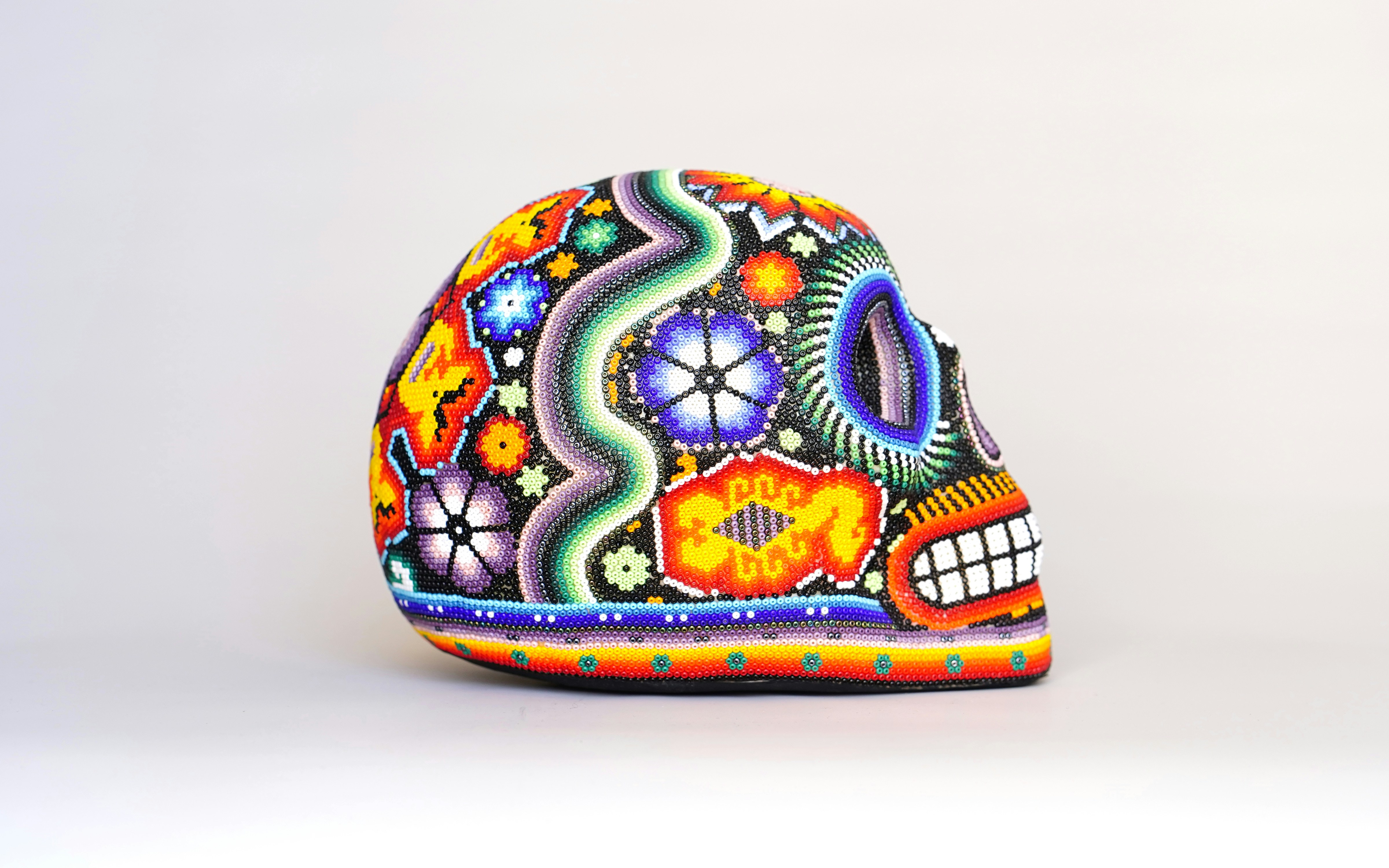 A multicolored skull shaped object on a white background photo – Free ...