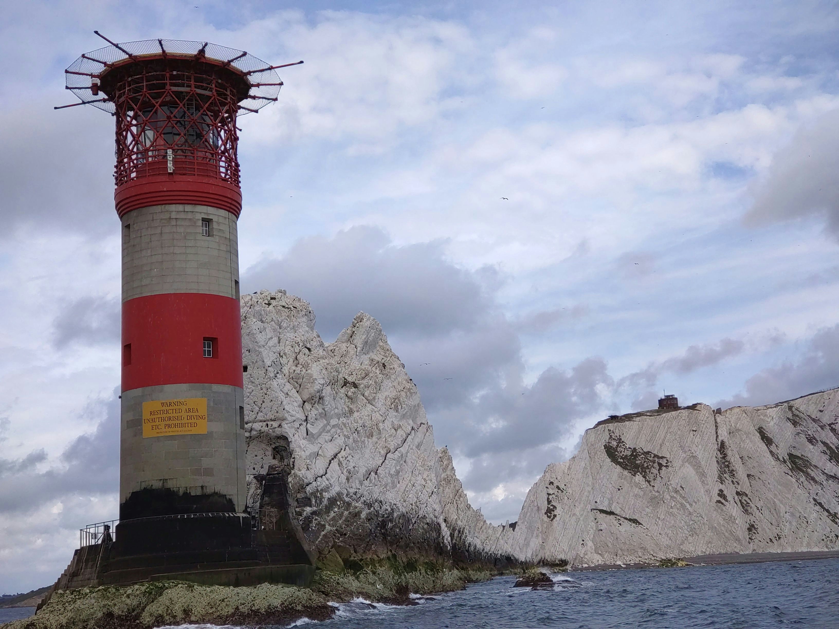 Lighthouse Sentinel Above the Sea of Chalk and Waves