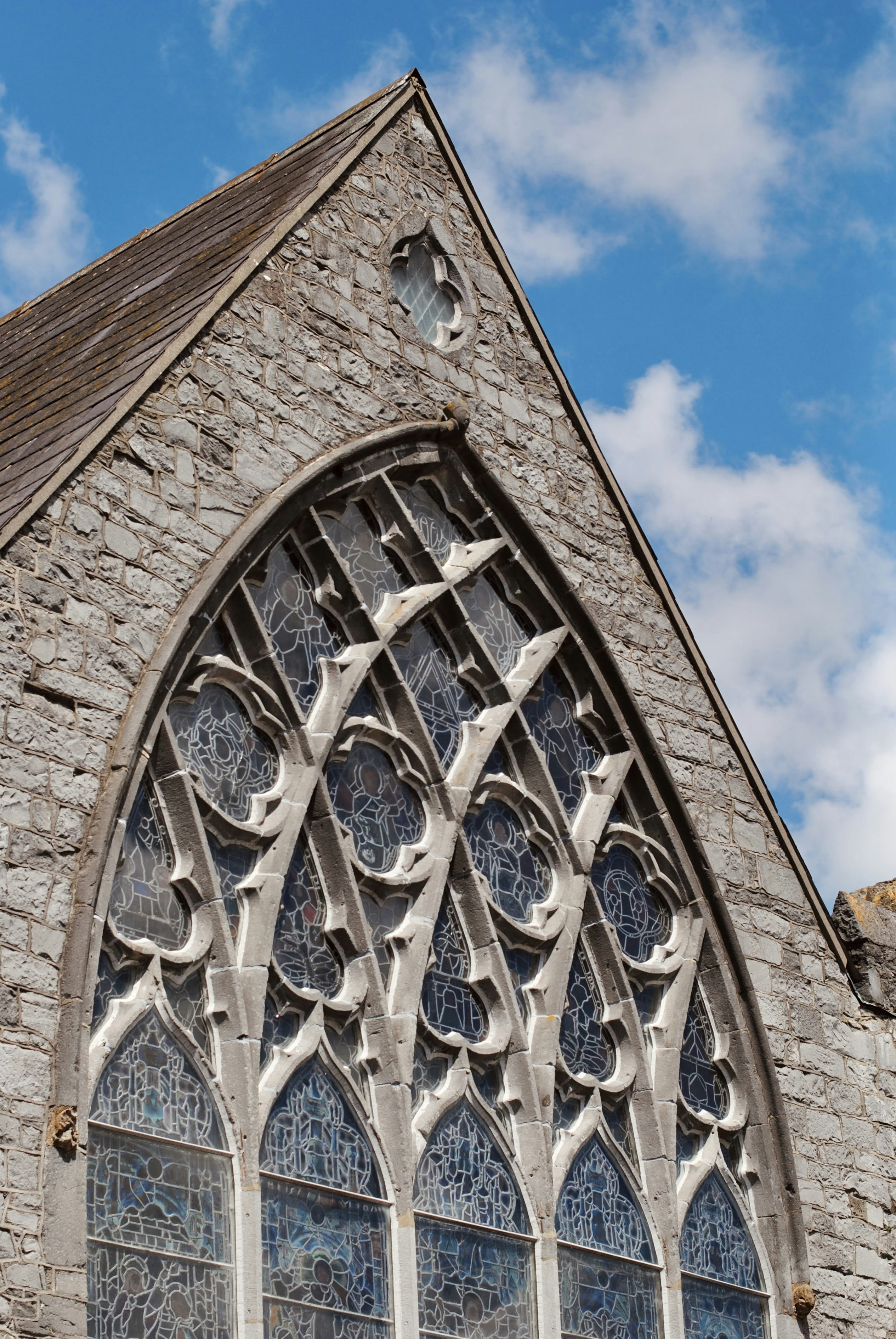 A large stone building with a very tall window photo – Free The black ...
