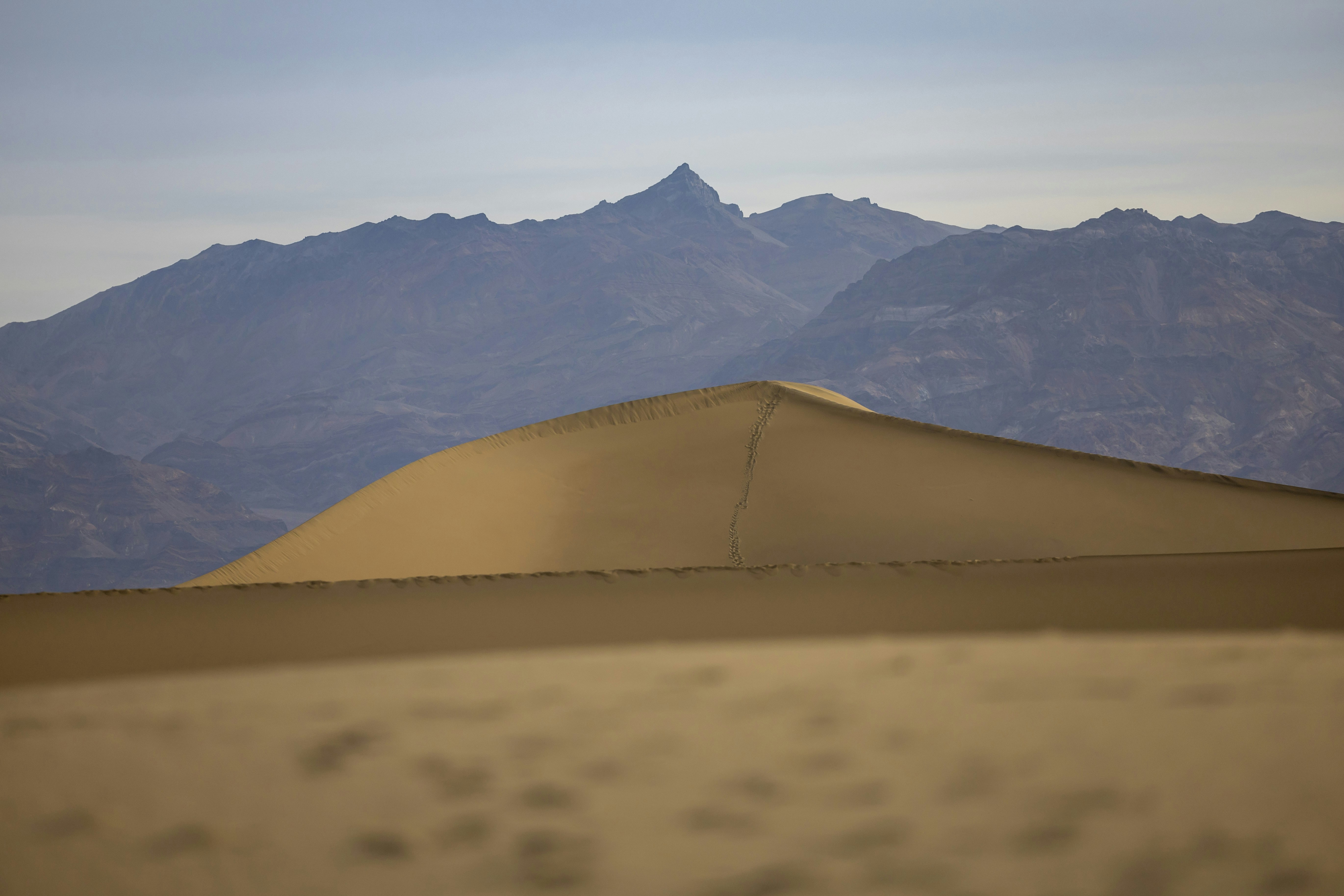 A desert landscape with mountains in the background photo – Free Sand ...