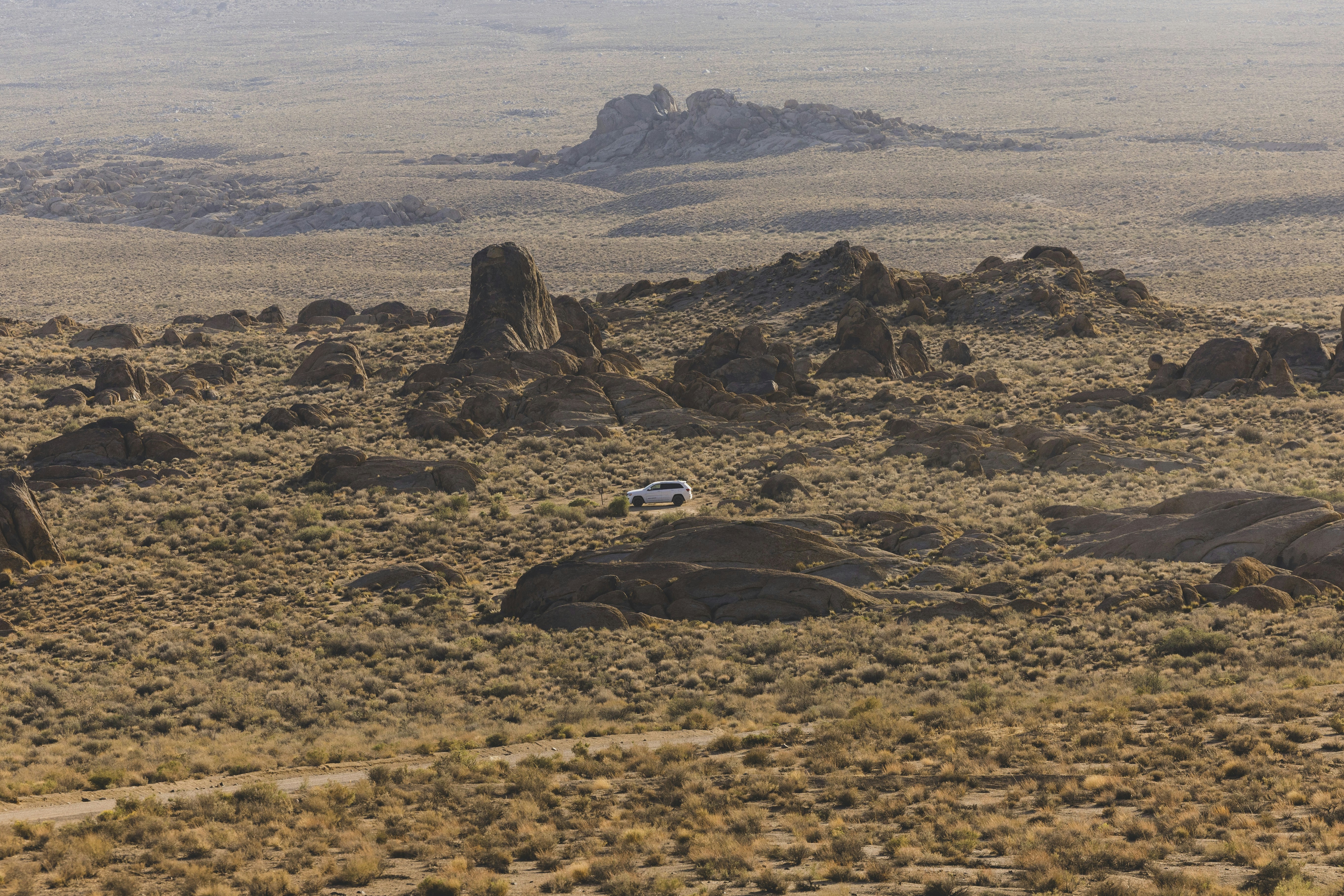 A car is parked in the middle of the desert photo – Free Alabama hills ...