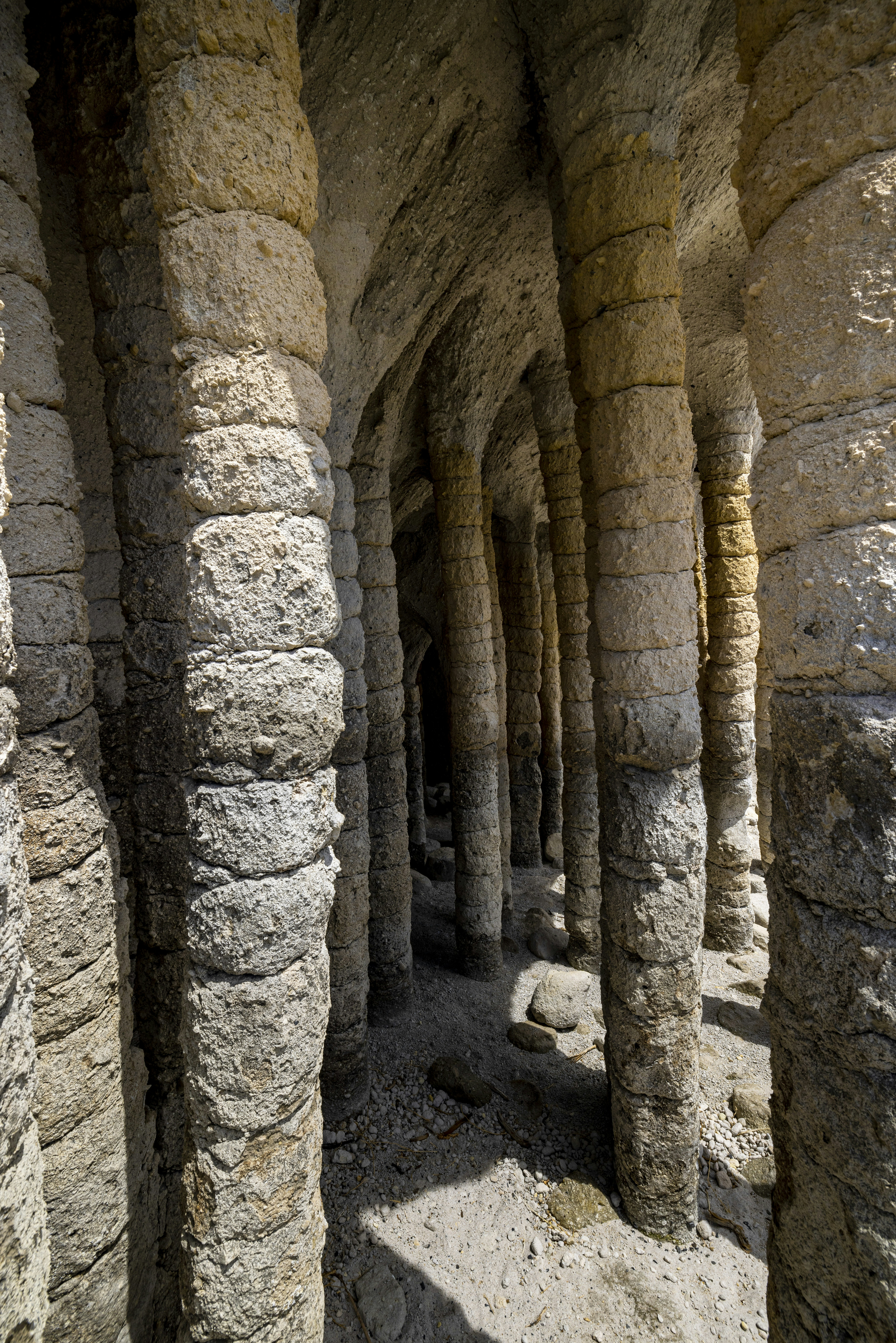 A long row of stone pillars in a stone building photo – Free Dungeon ...