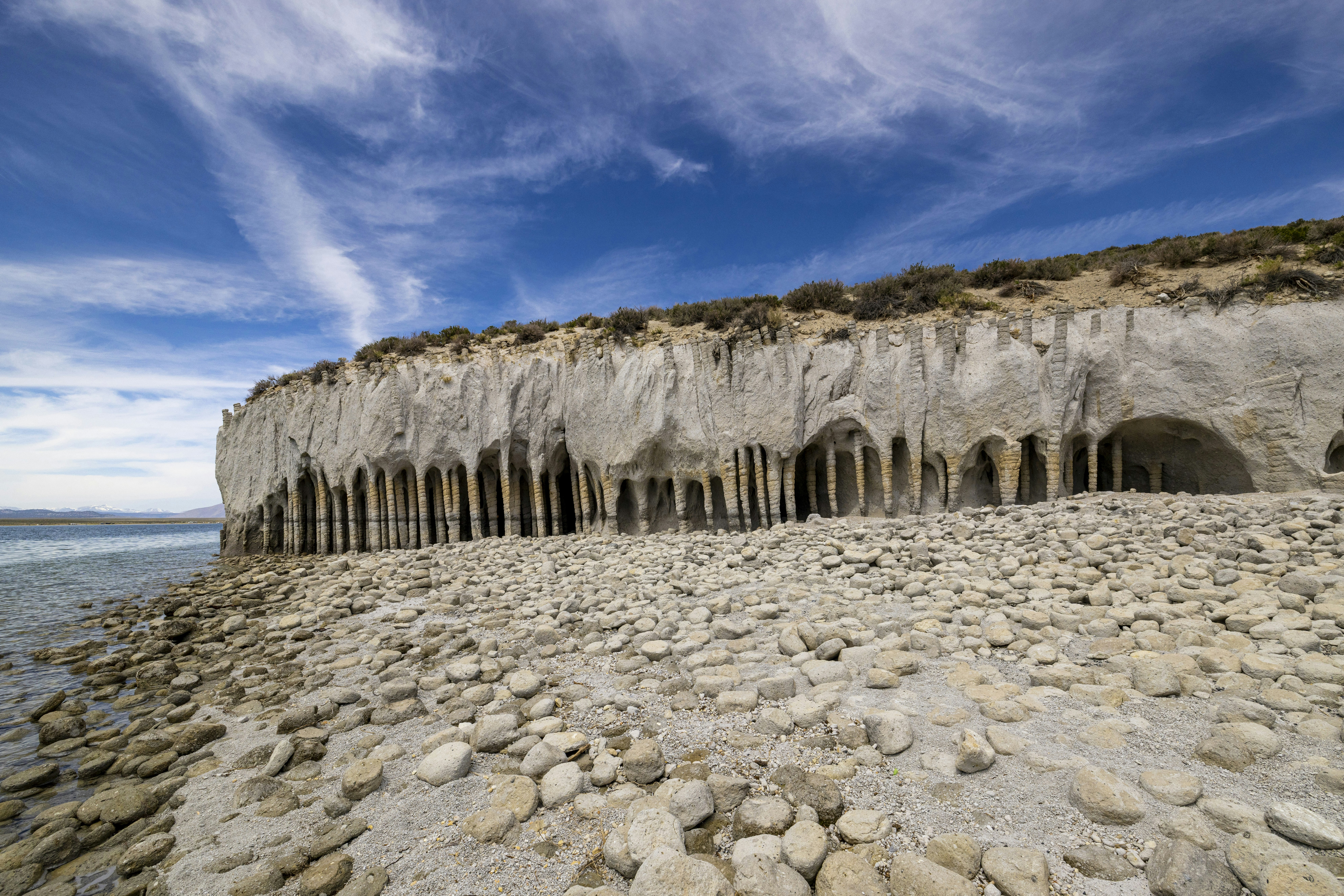 A rocky beach with a large formation of rock formations photo – Free ...