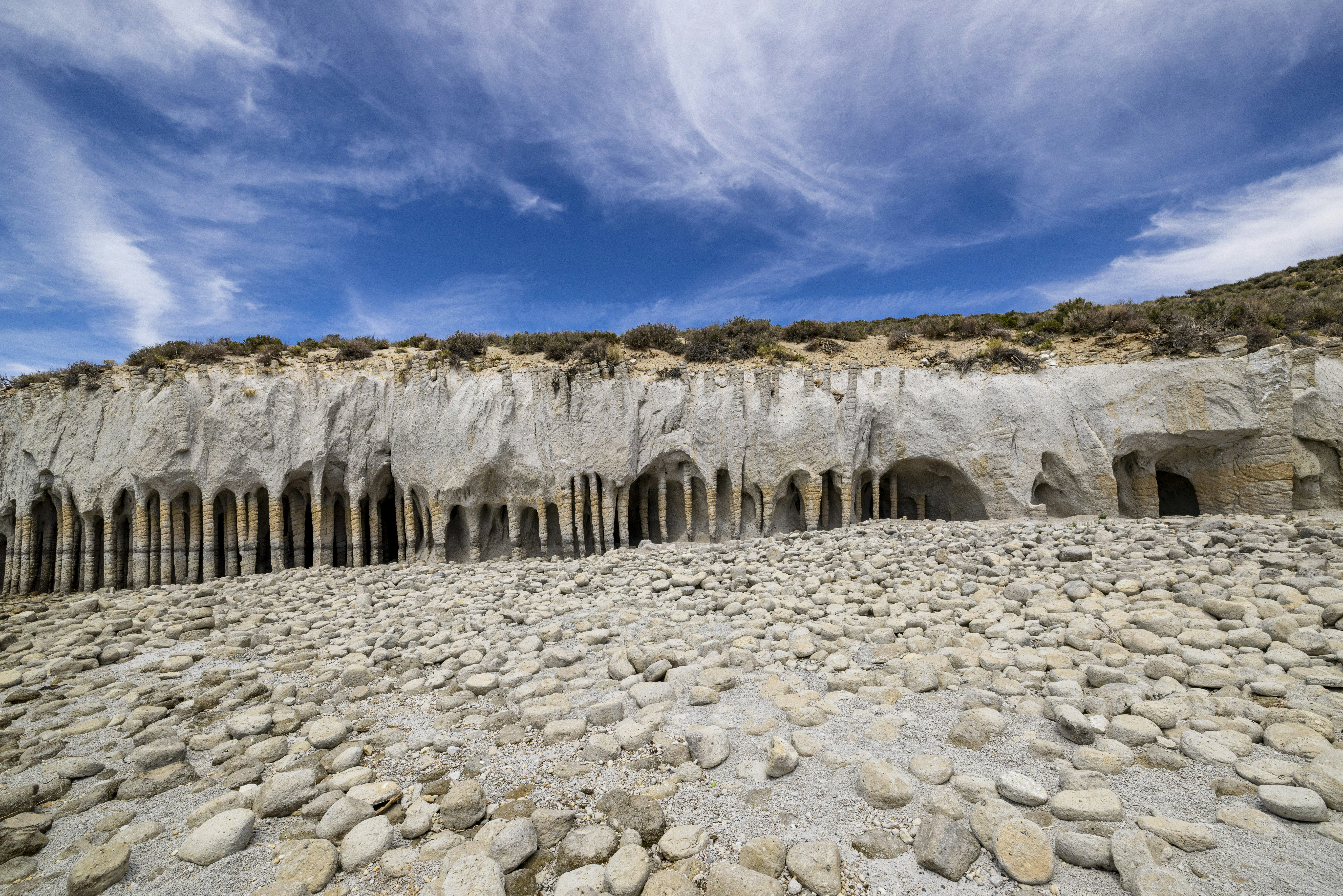 A rocky area with a bunch of rocks on the ground photo – Free Blue ...