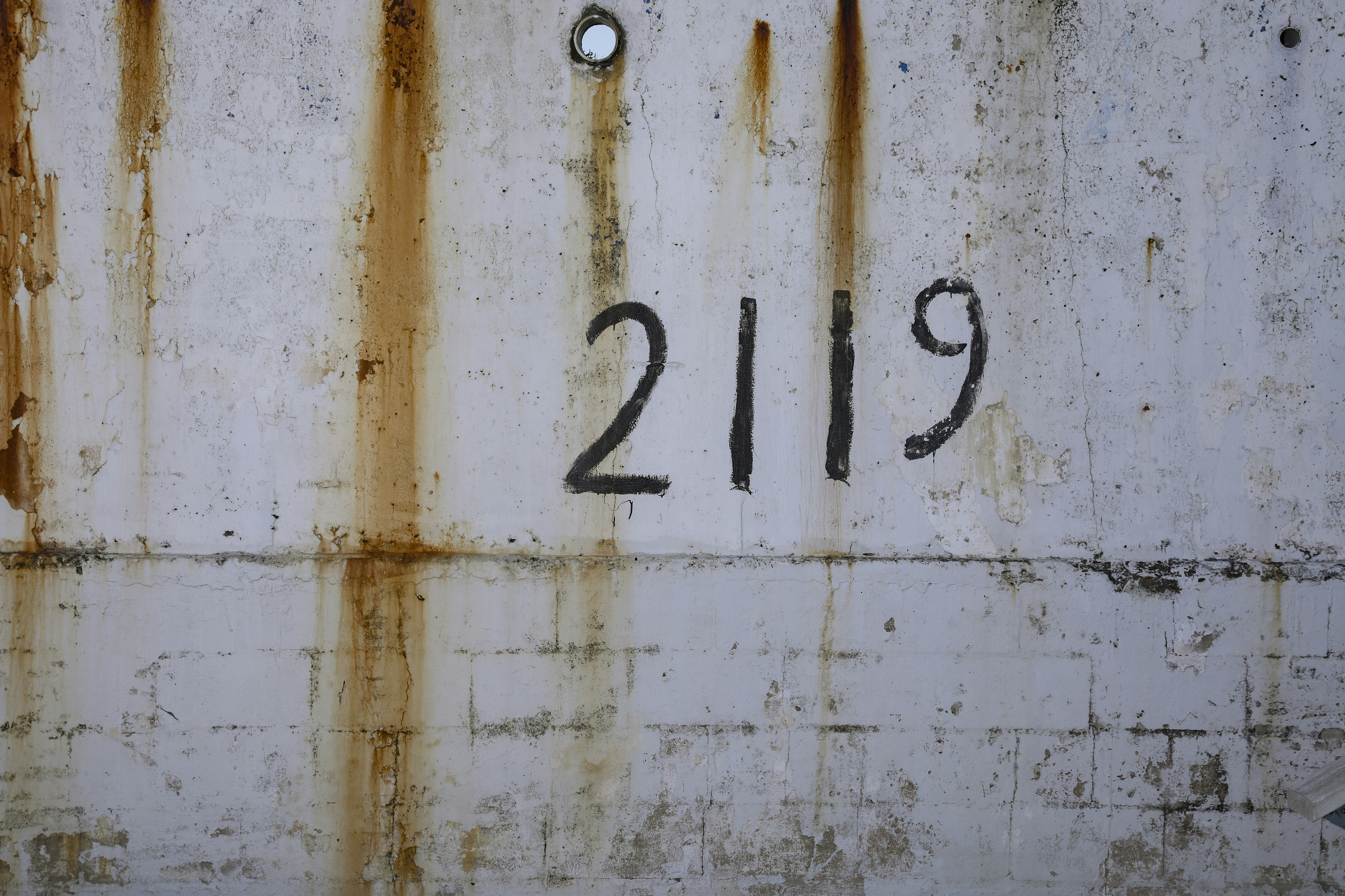 A rusted metal wall with the number 2139 painted on it photo – Free ...
