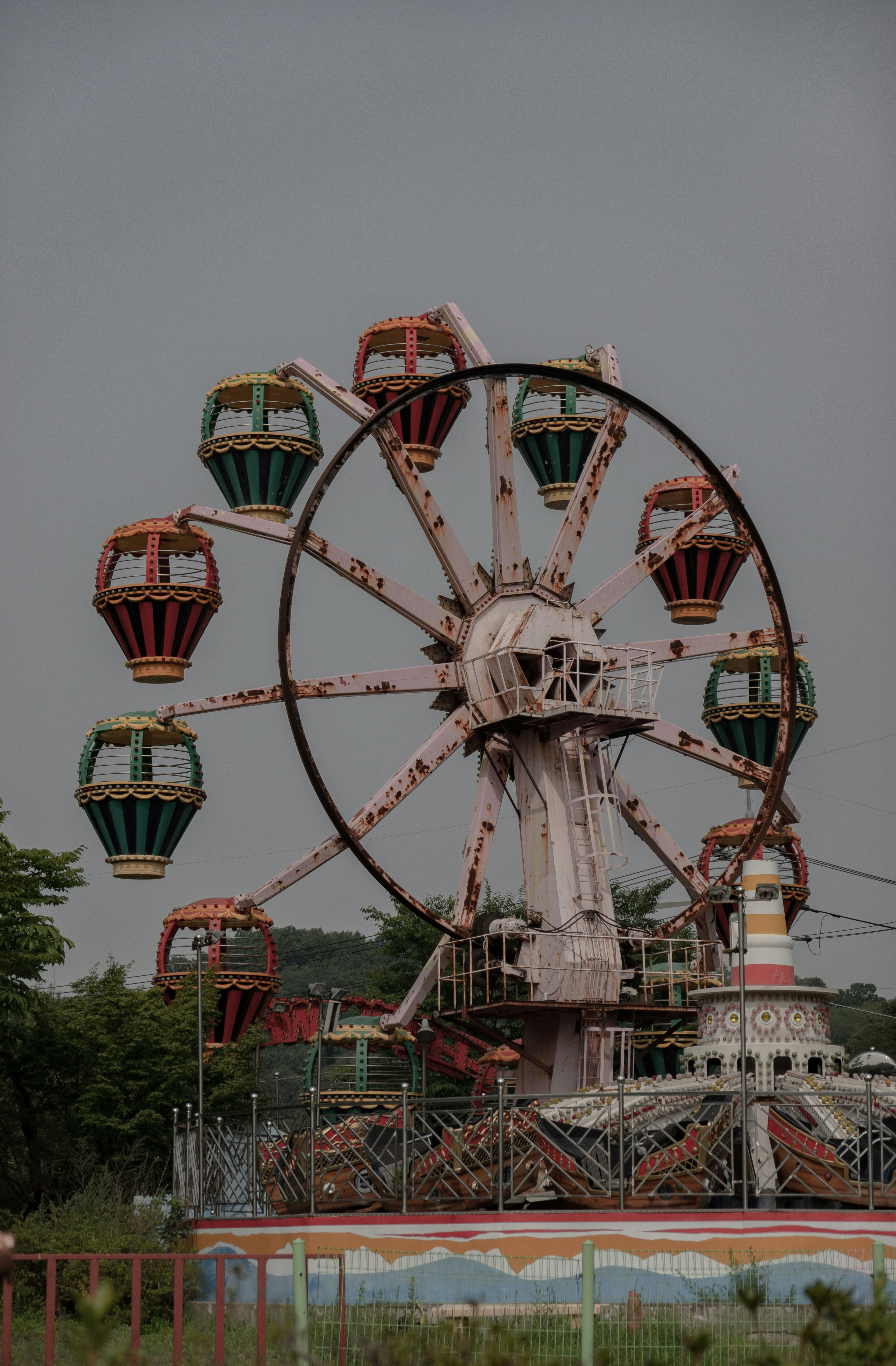 a large ferris wheel sitting in the middle of a park