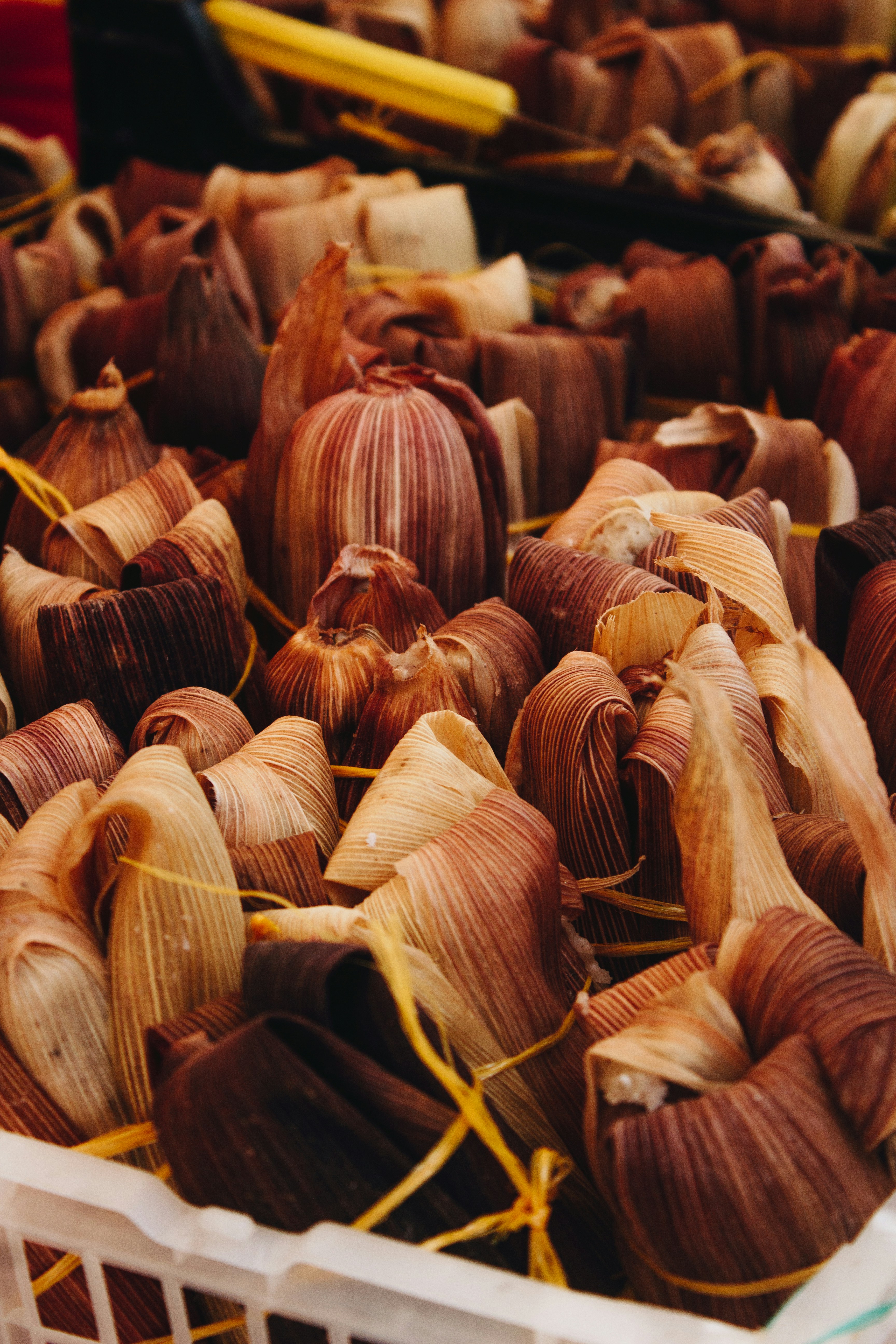 Amber Leaf Parcels Bound with Golden Threads in a Market Crate