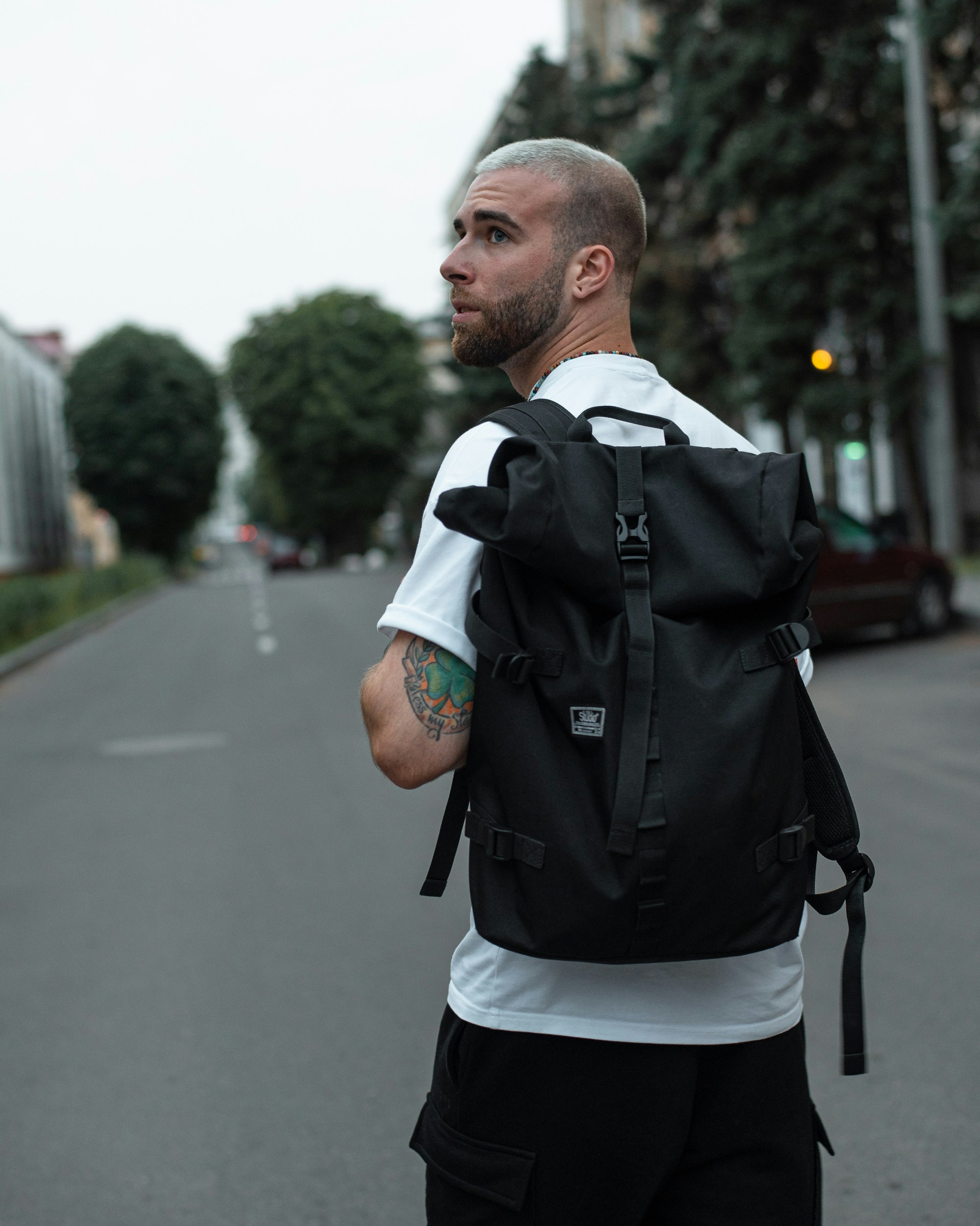 A man with a tattoo wearing a black backpack photo – Free Man model ...