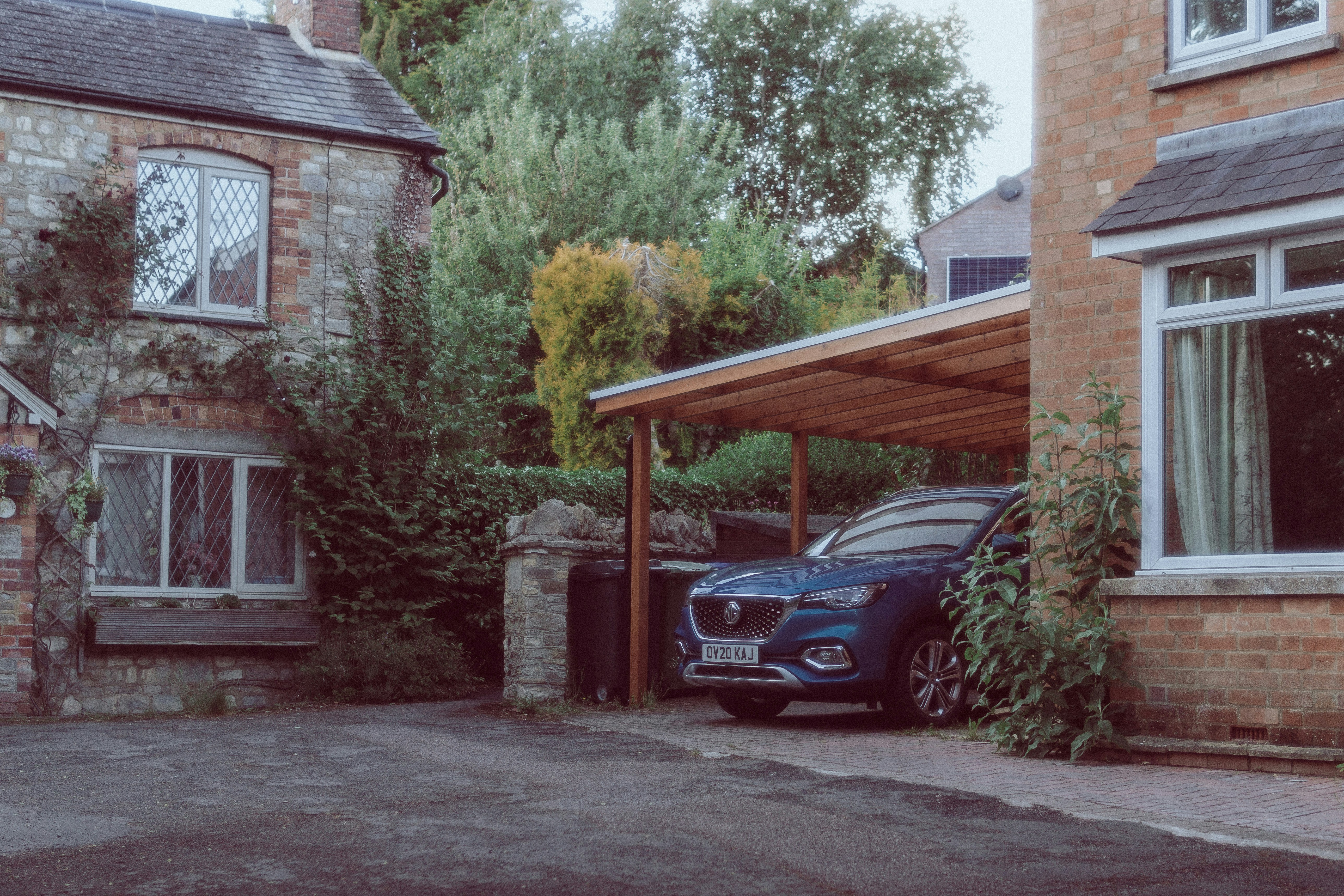 Blue SUV in the Carport: Modern Contrast Against a Traditional Brick Home