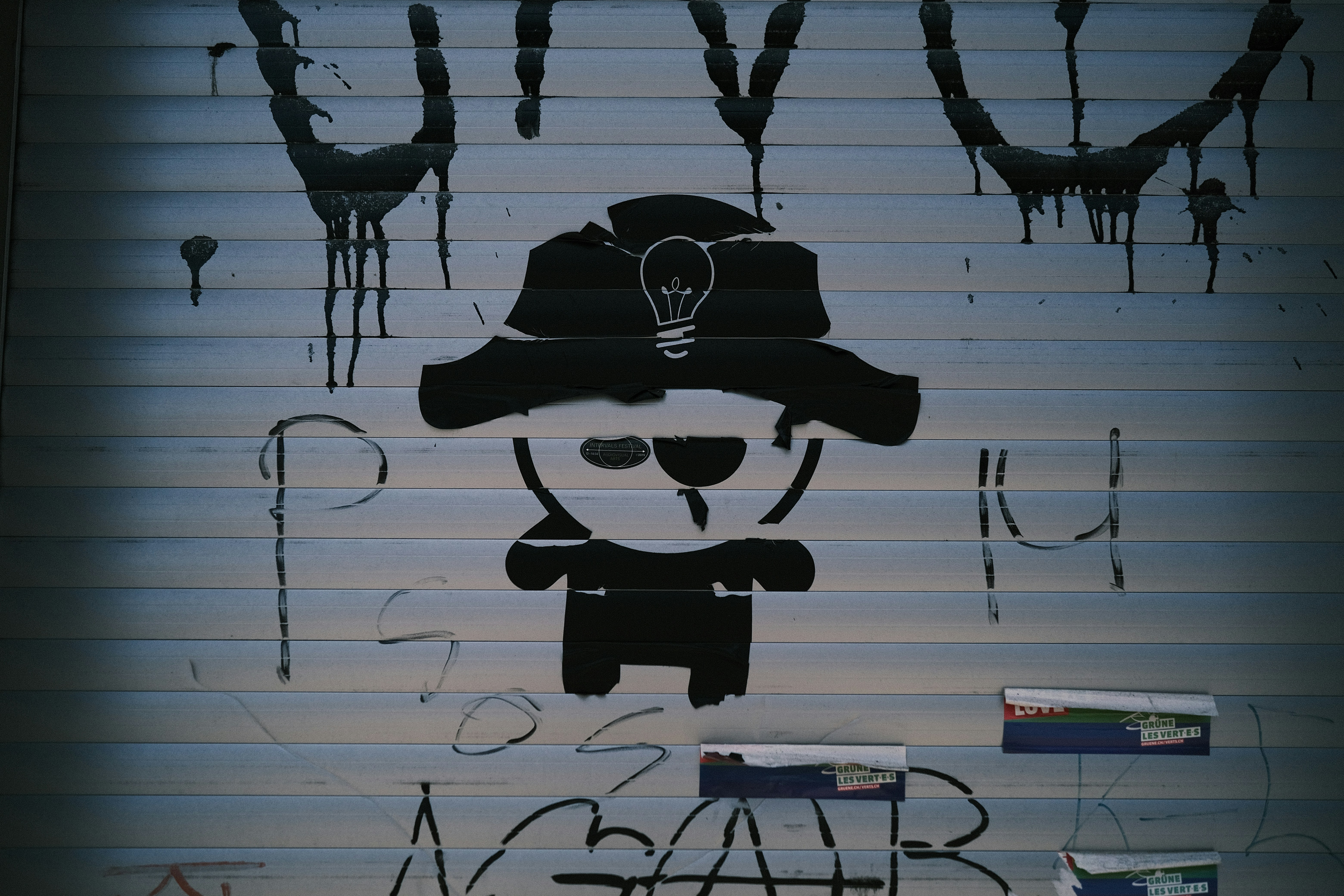 Lightbulb Hat Graffiti: A Cartoon Portrait on a Weathered Blue Door
