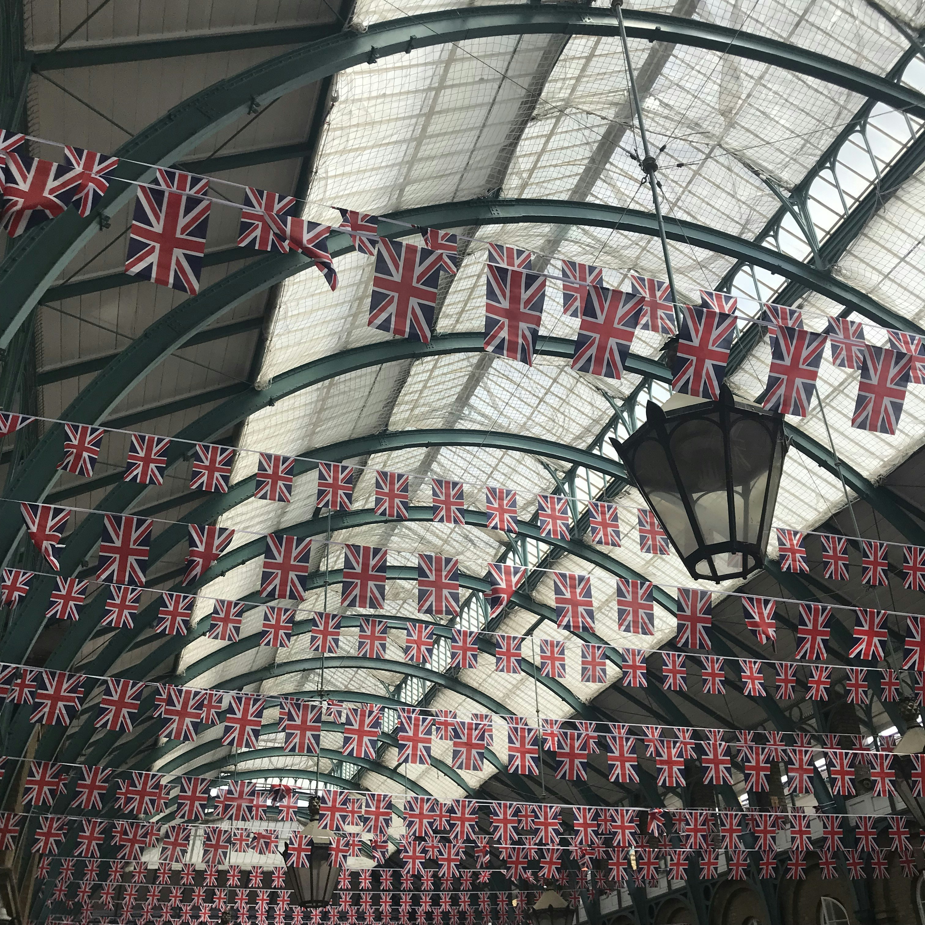 A train station with a lot of flags hanging from the ceiling photo ...