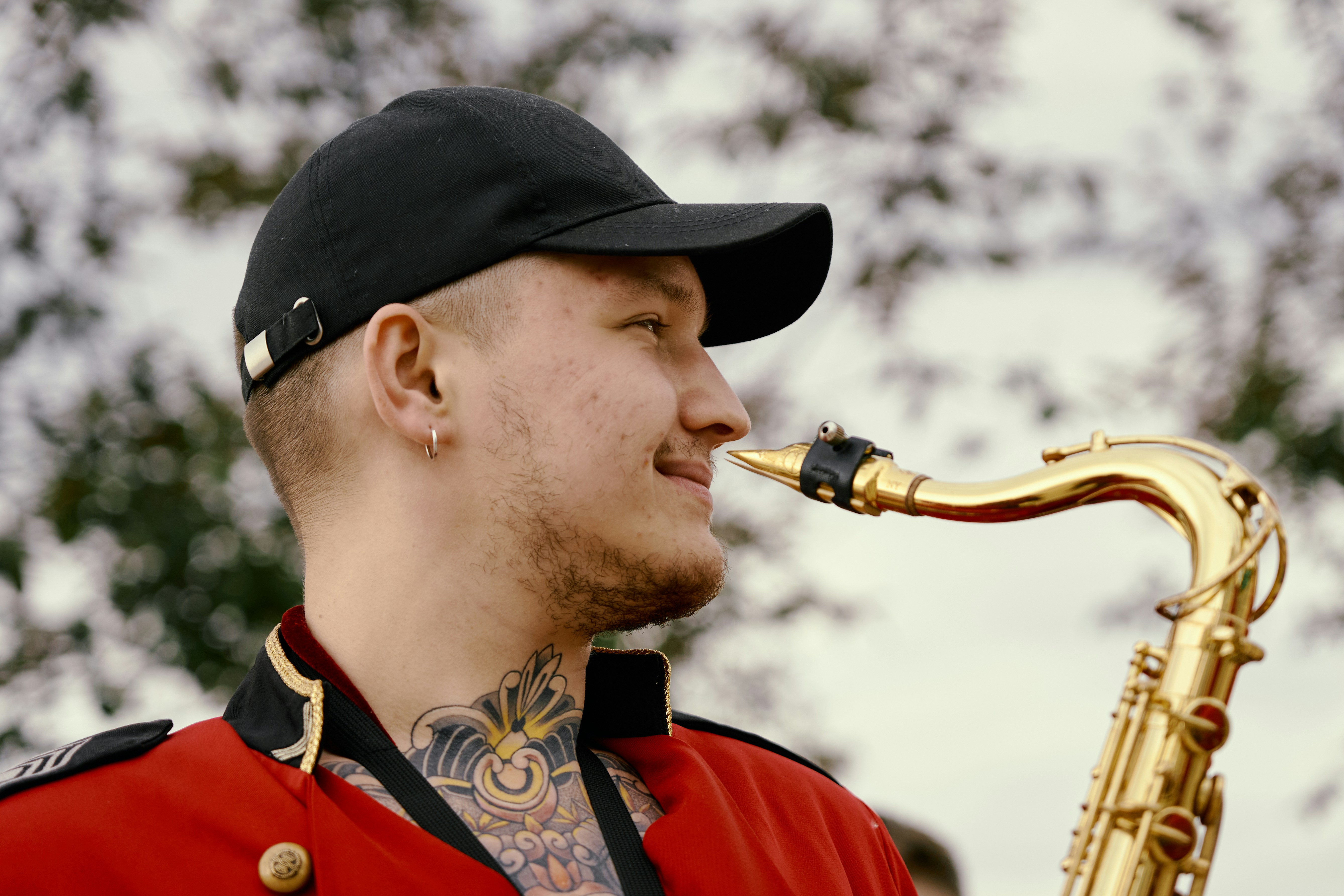 A man with a tattoo playing a saxophone photo – Free Human Image on ...