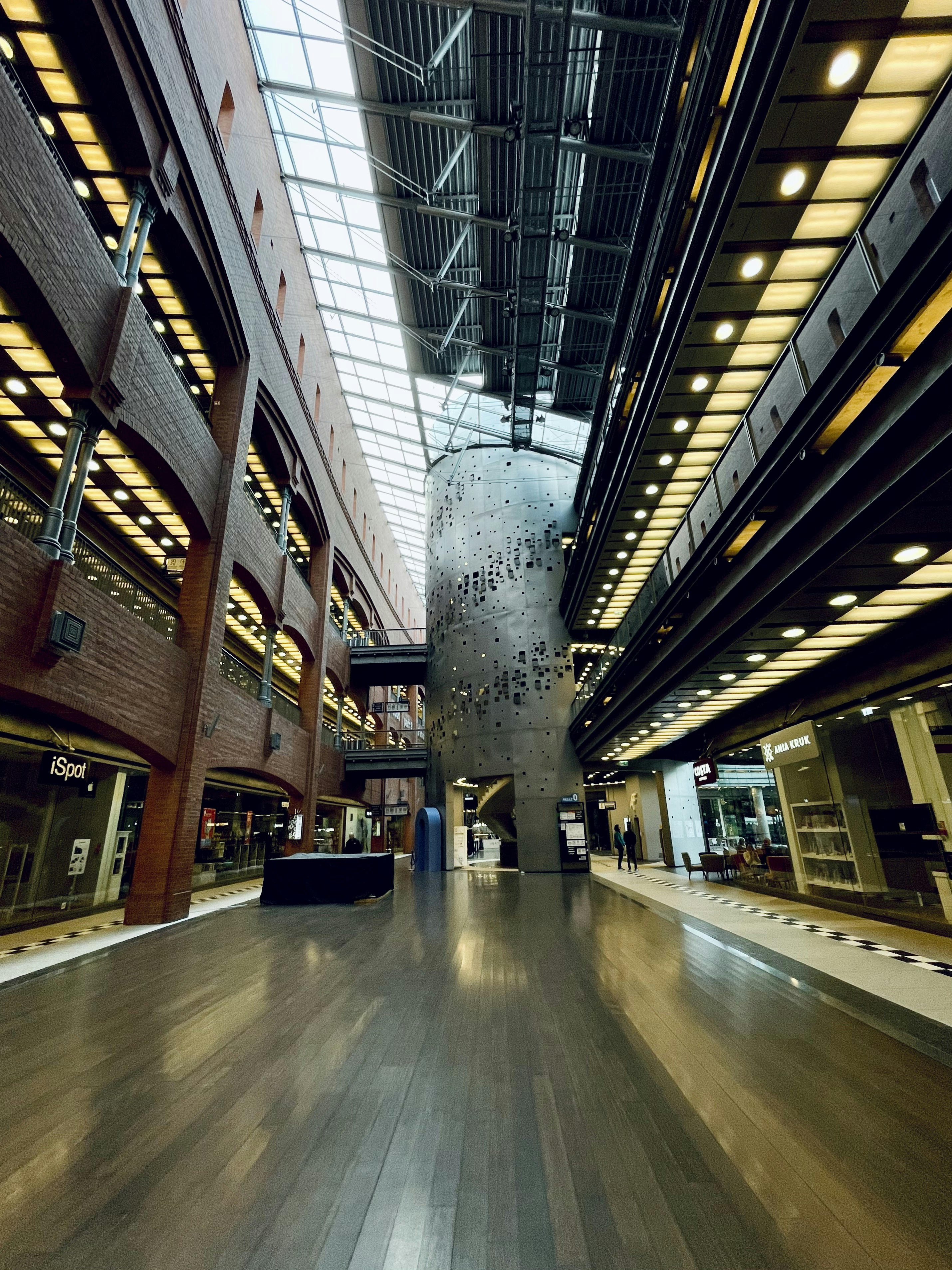 Monument at the Core: Perforated Steel Column in a Glass-Canopy Atrium