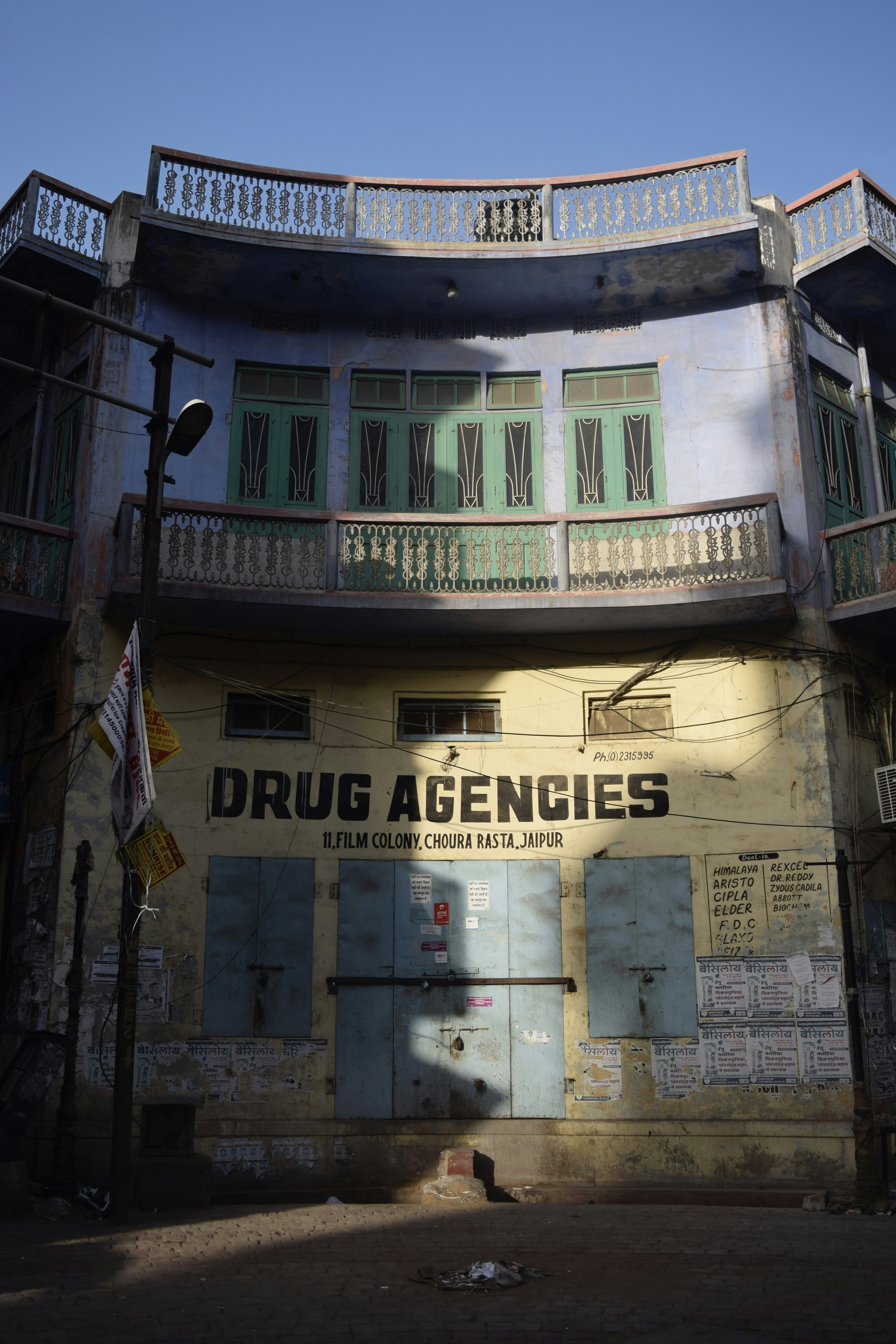 Weathered drug agency facade under late afternoon light