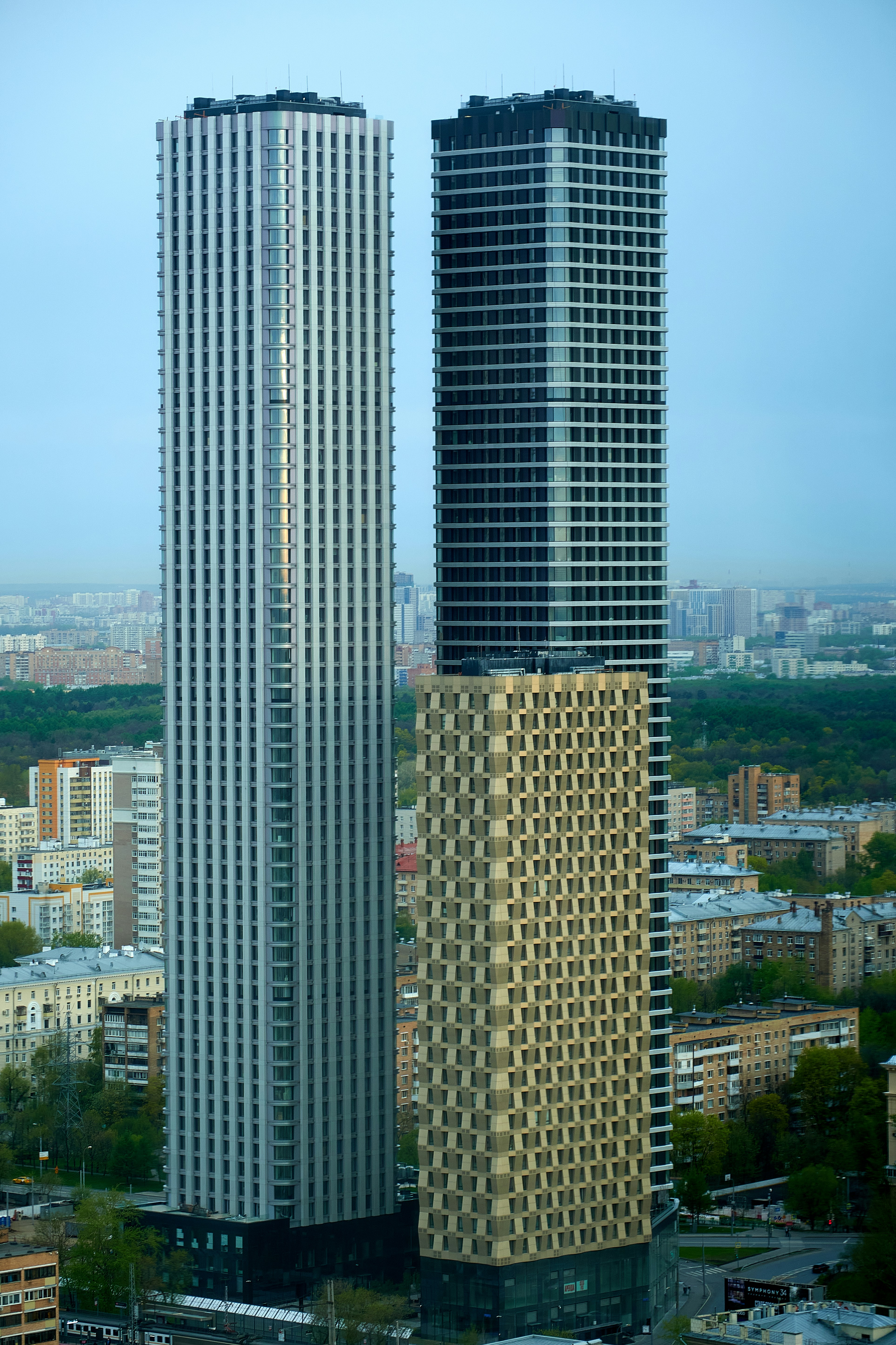 A couple of tall buildings sitting next to each other photo – Free ...