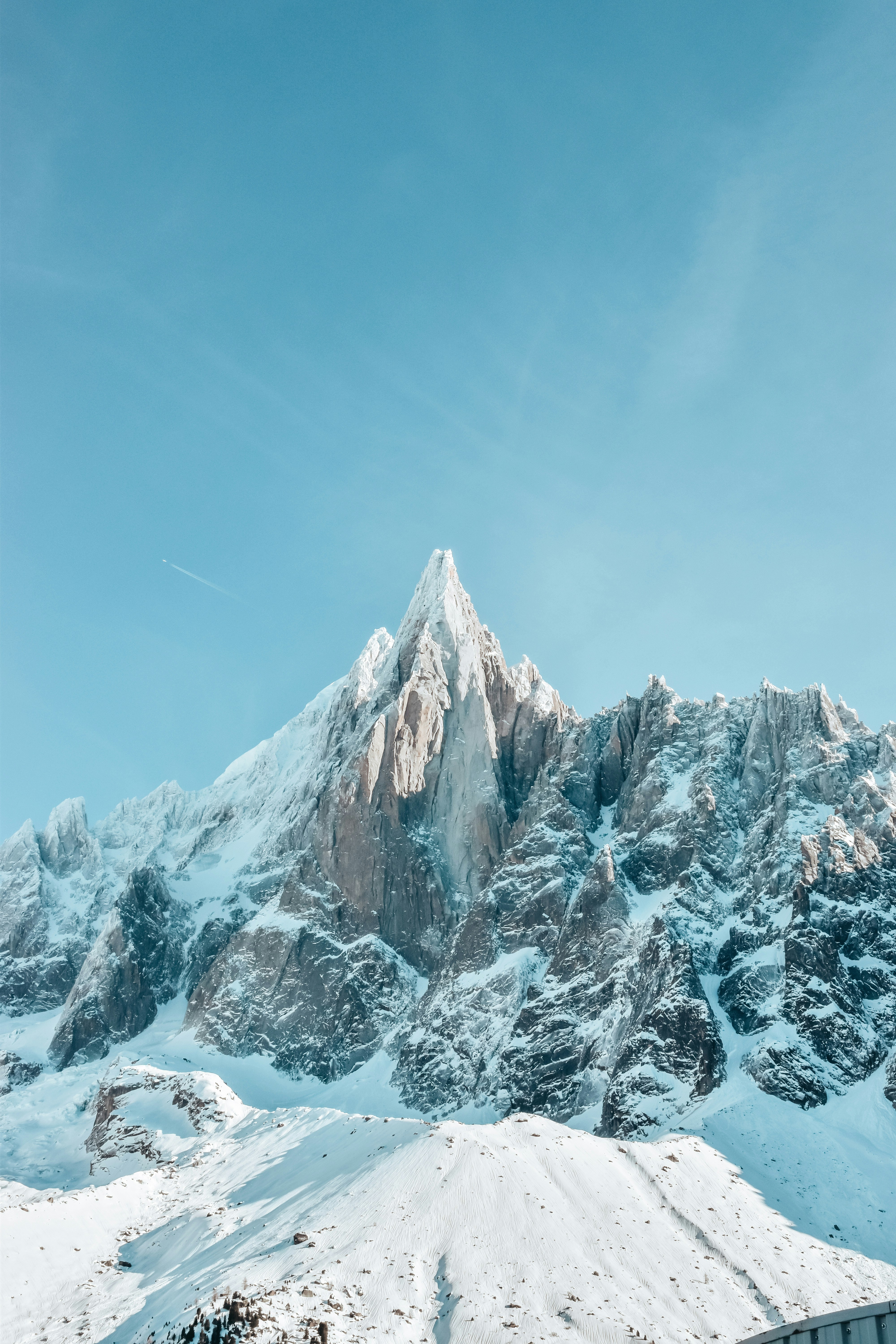 Cerulean Summit: Snow-Crowned Spire Against a Pristine Alpine Sky