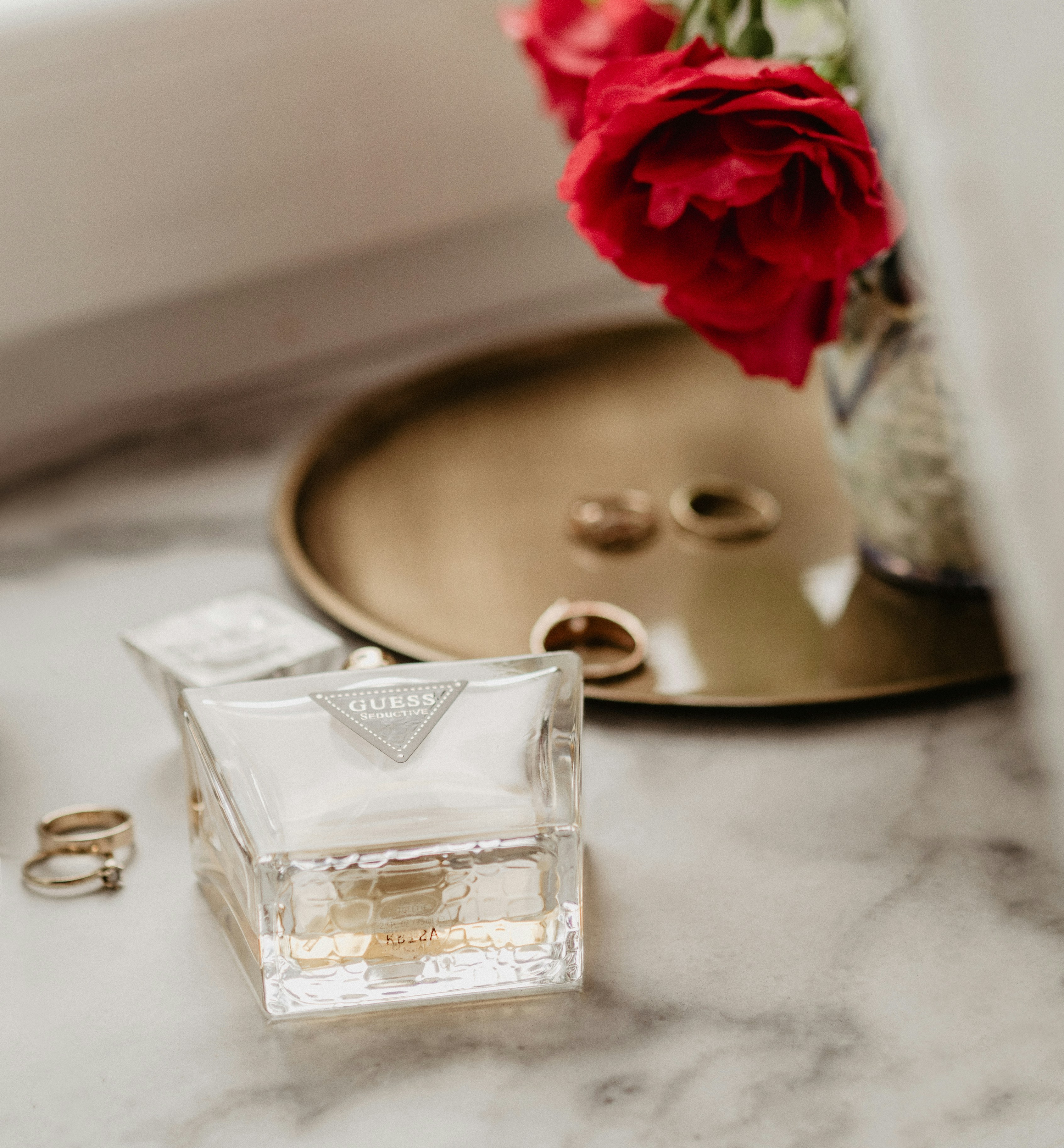 Crystal Elegance: Rings and Rose by Marble Surface