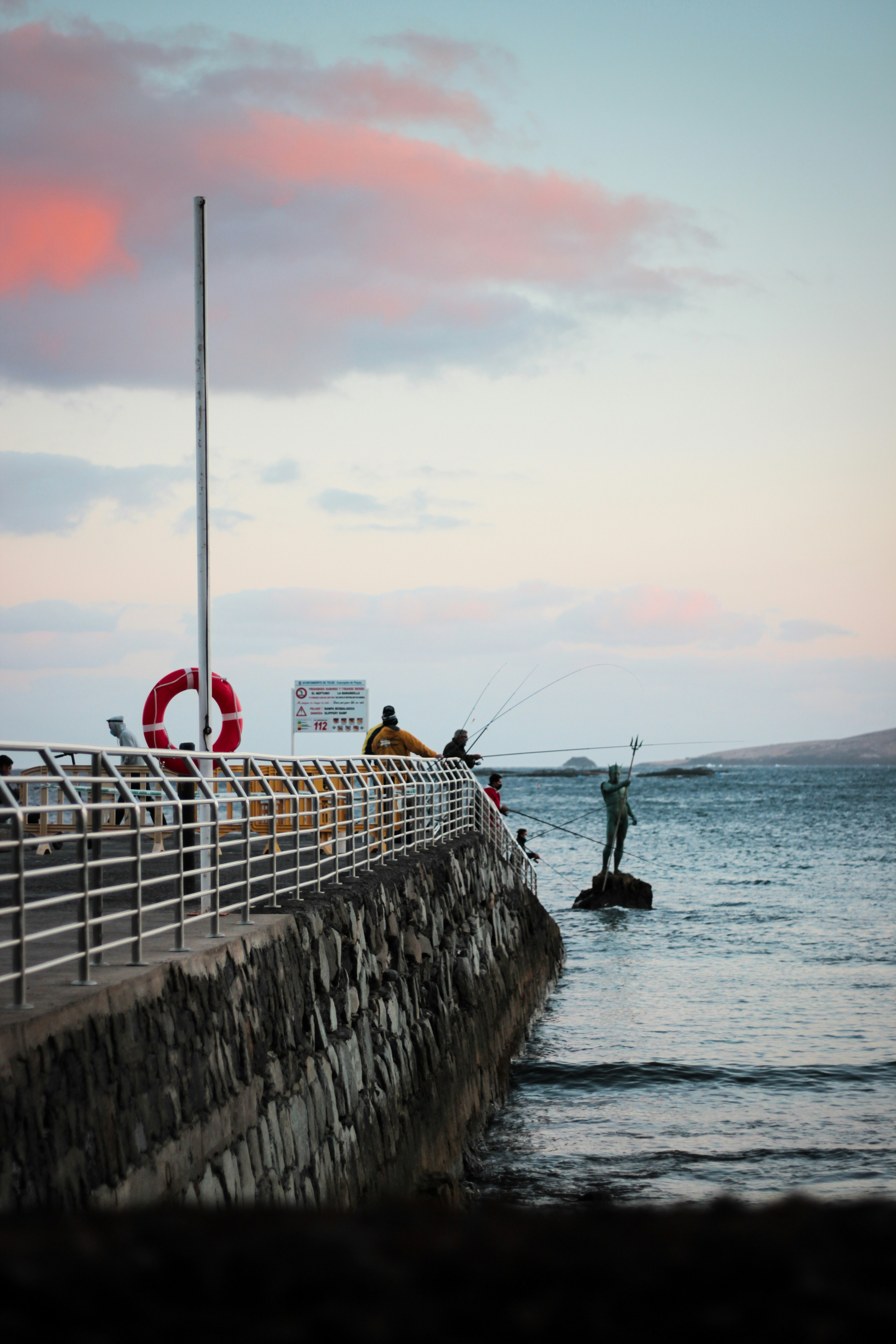 Dusk at the Pier: The Green Sentinel at the Jetty's End