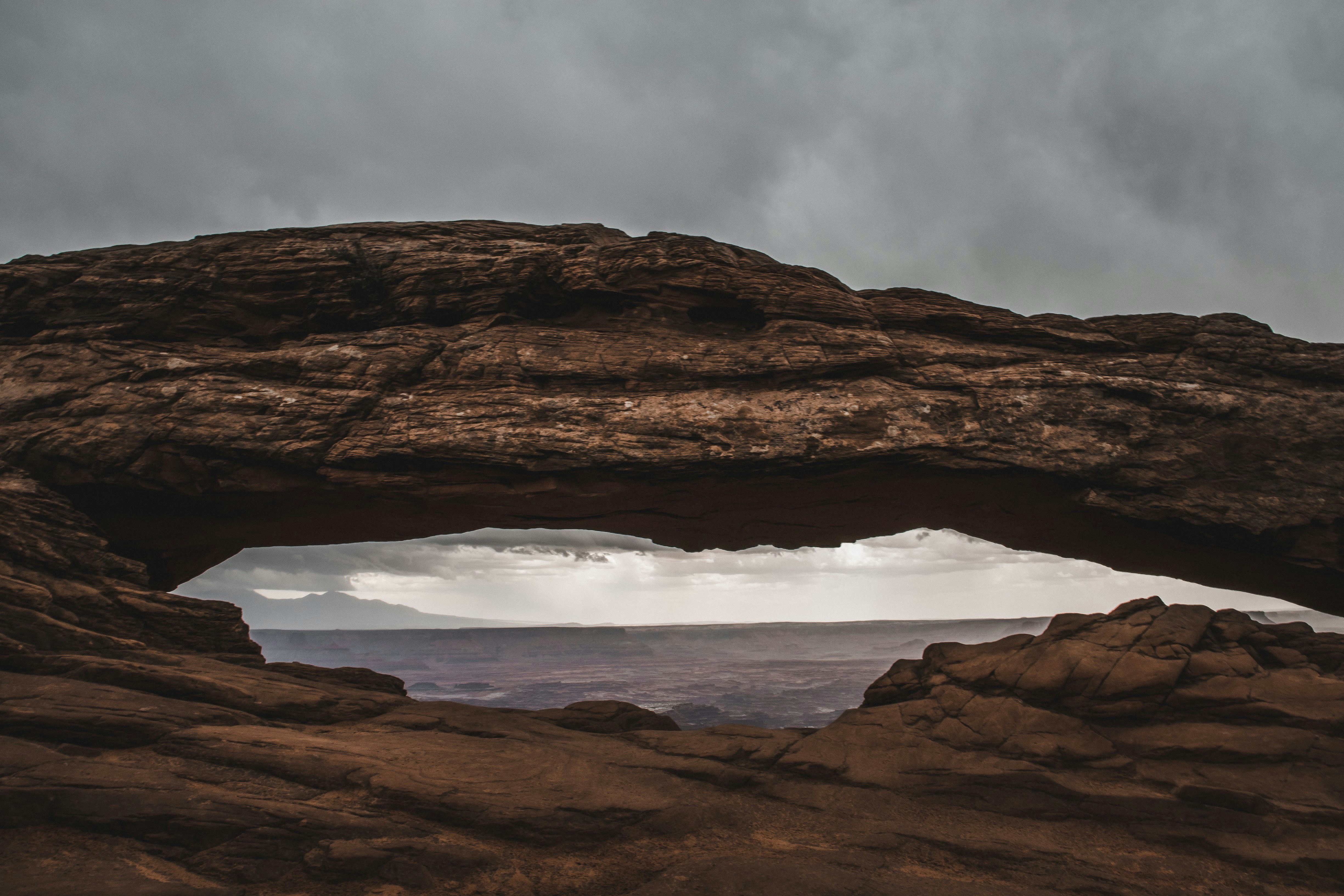 A large rock formation with a hole in the middle photo – Free Grey ...