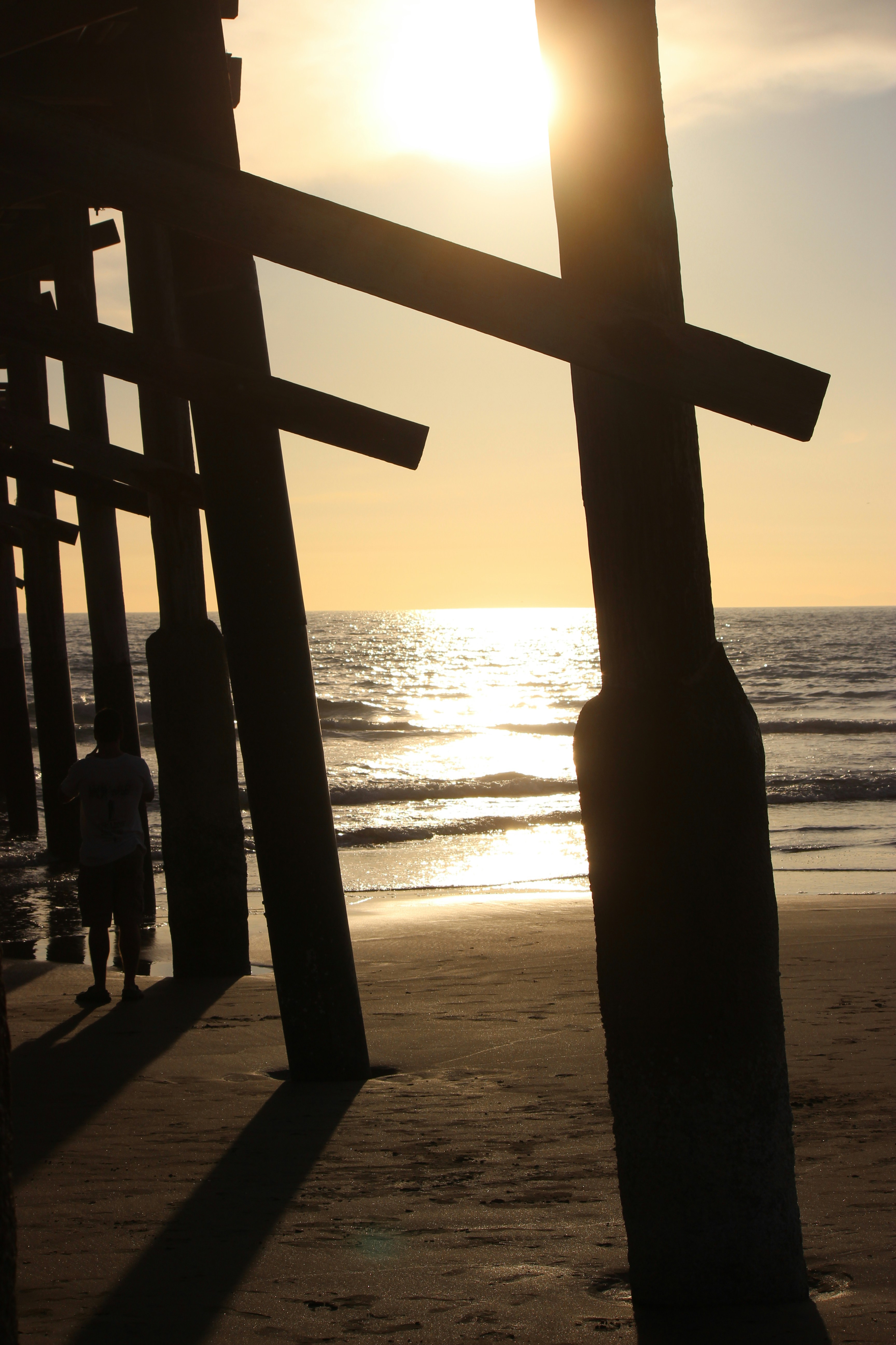 Pier Shadows at Dusk: A Silhouette Study on the Golden Shore