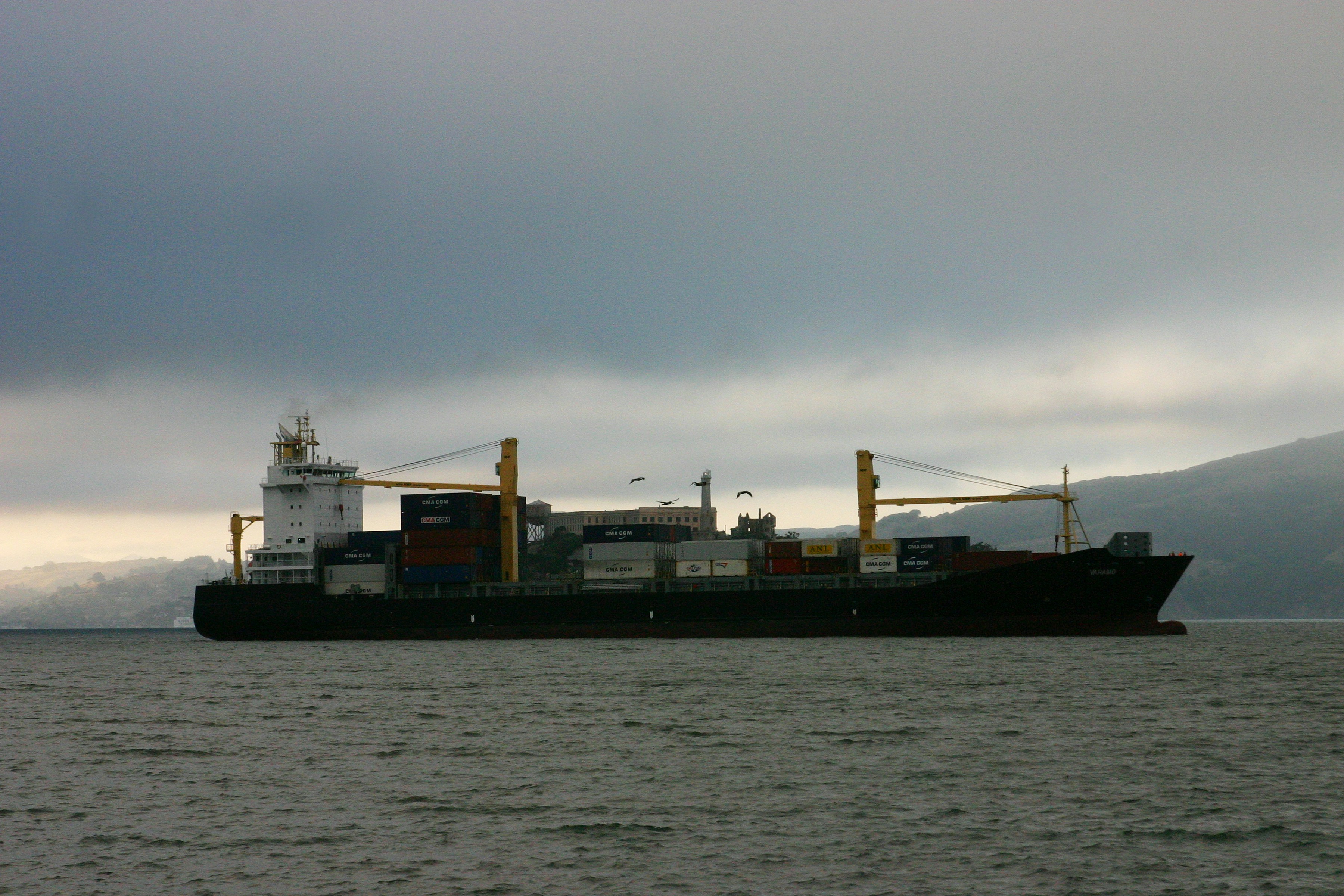 A large cargo ship in the middle of the ocean photo – Free Ca Image on ...
