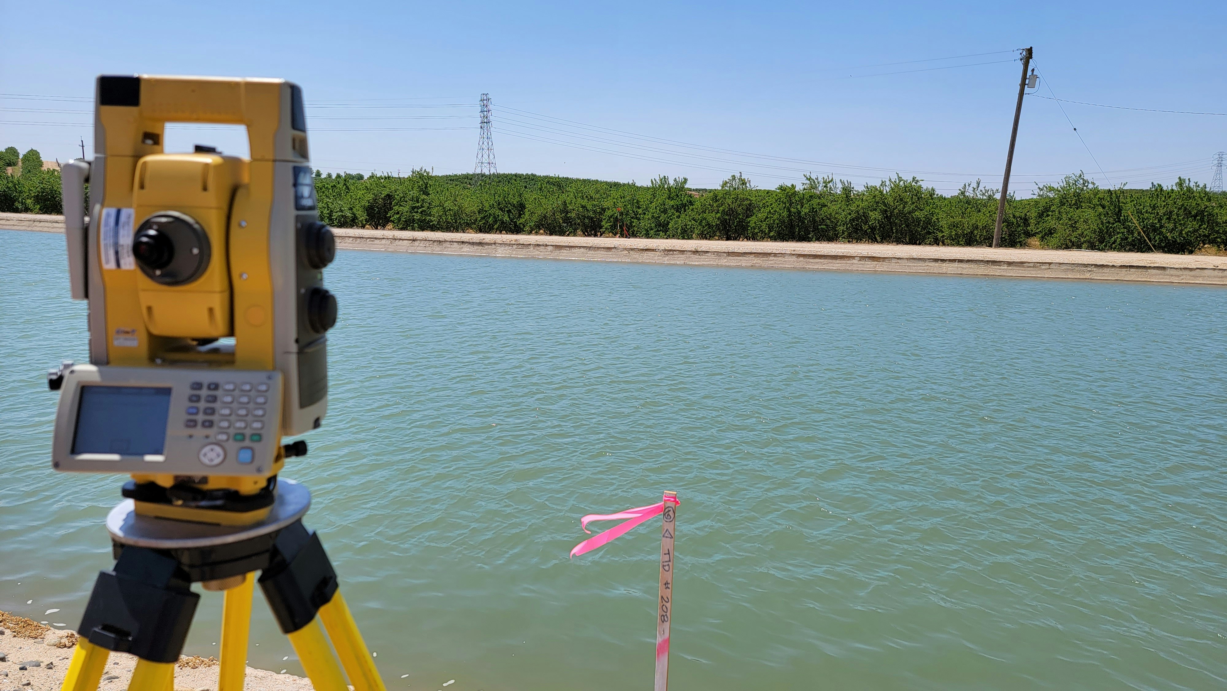 A yellow tripod with a camera on top of it near a body of water photo ...