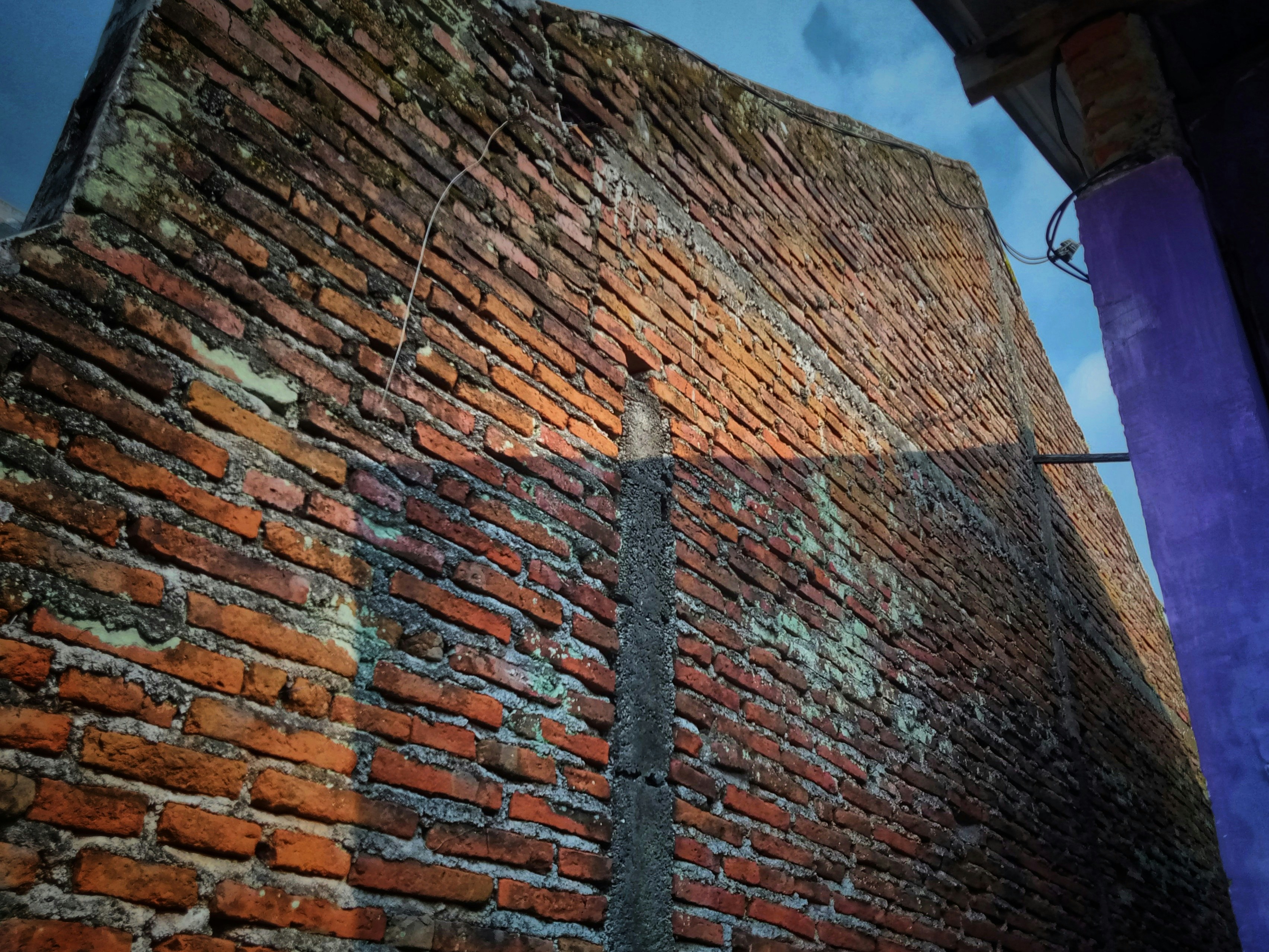 Brick Wall Geometry under a Blue Sky with Urban Accent