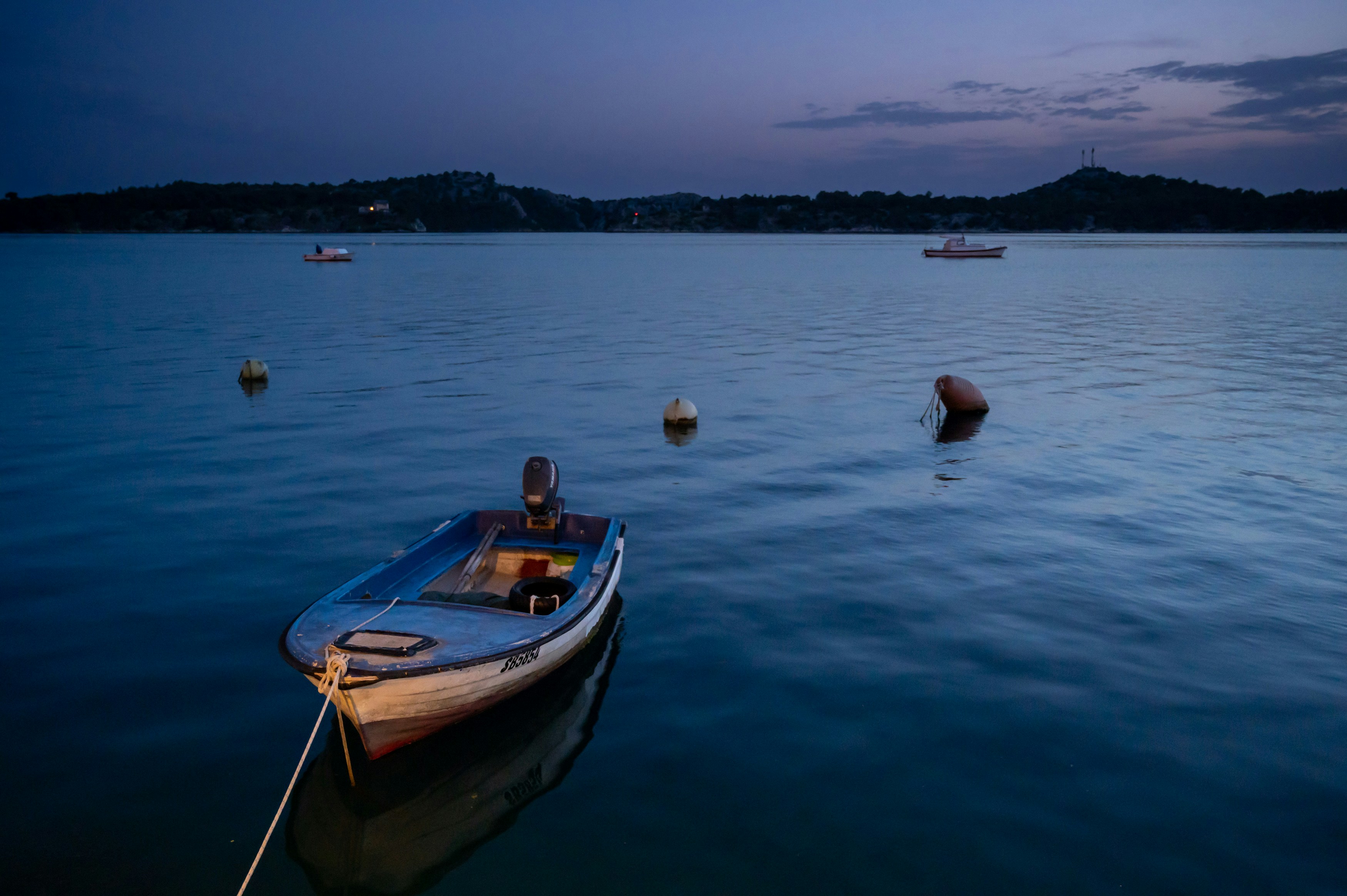 a small boat floating on top of a large body of water