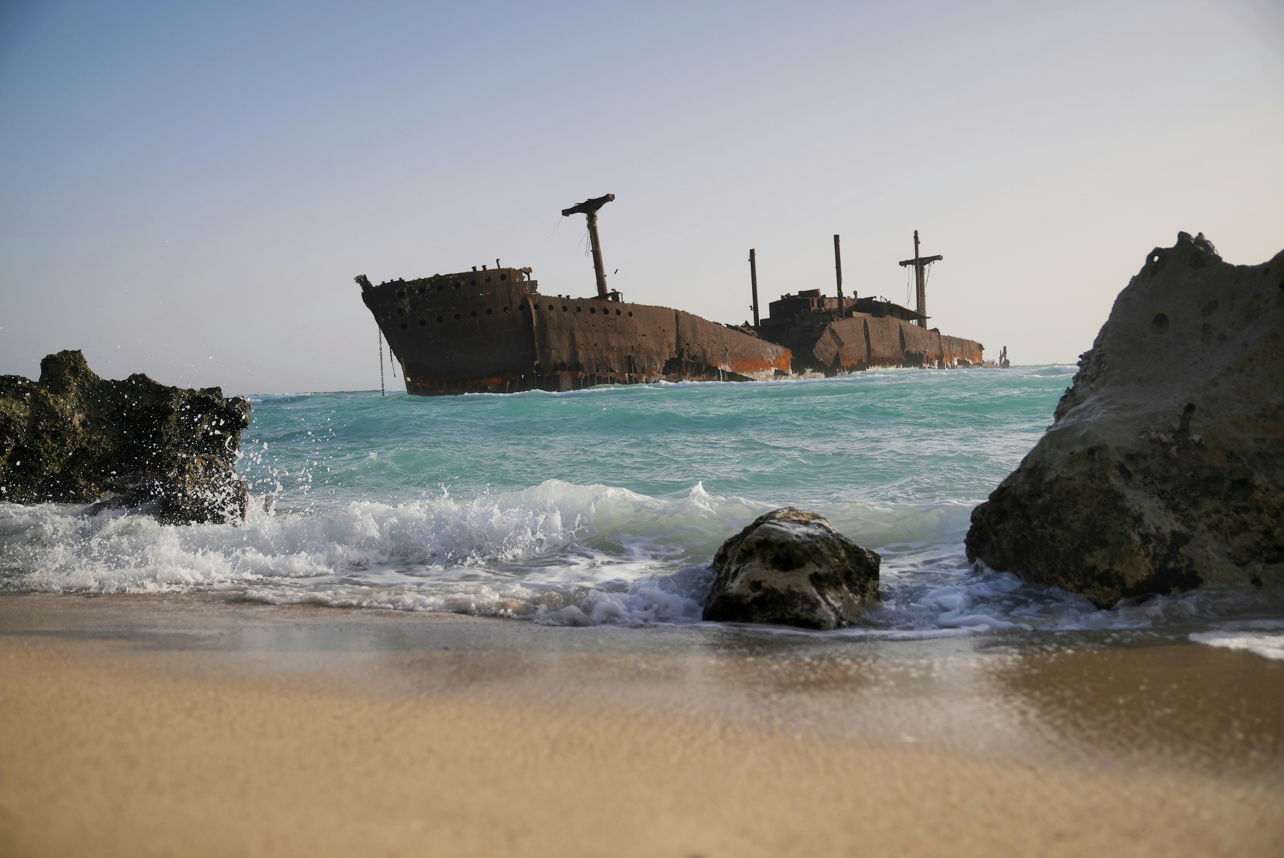 Beached Galleons in Turquoise Surf: The Rusted Wreck at Coral Shore