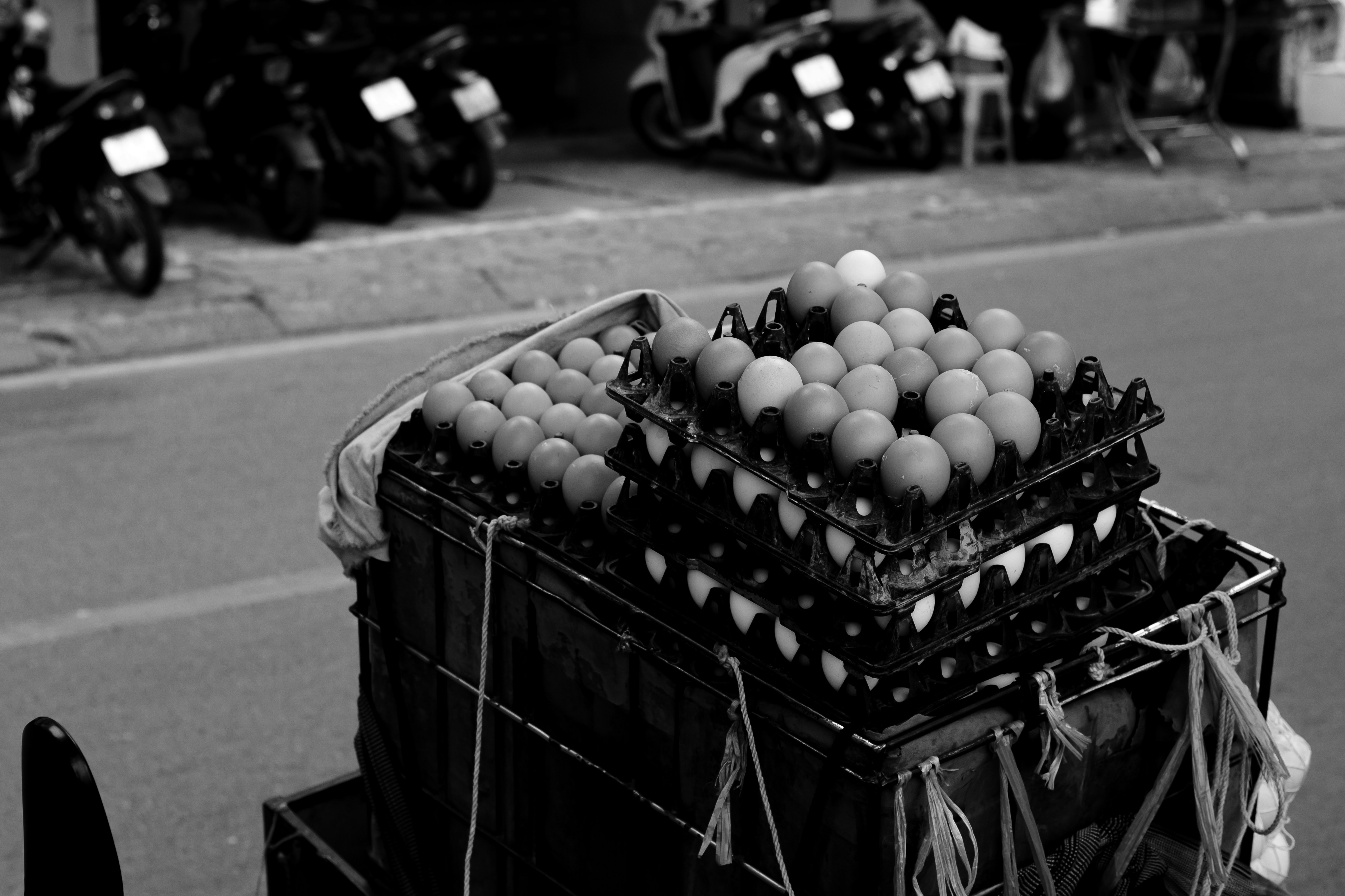 Monochrome Market: Stacked Egg Crates on a Street Cart