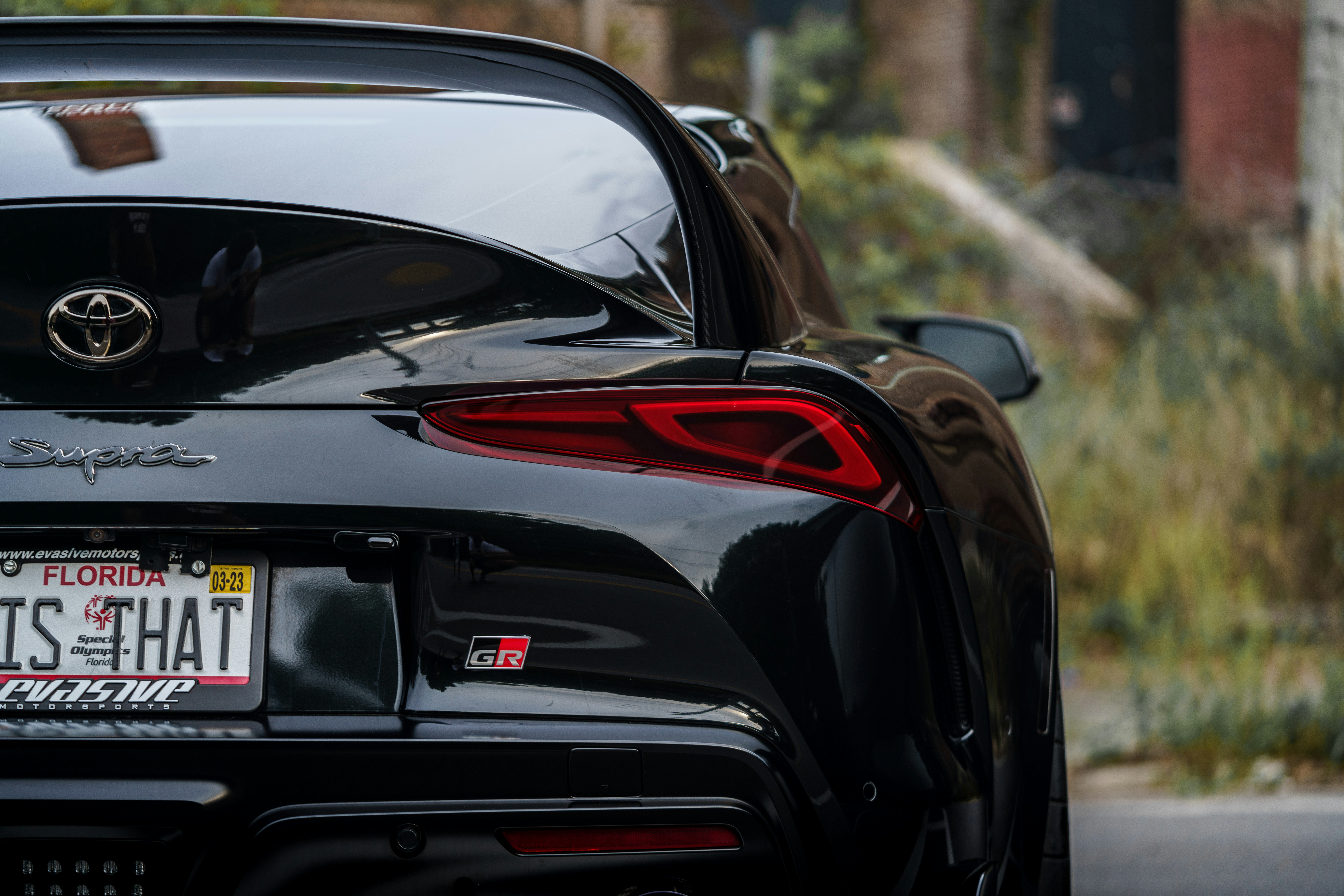 A close up of the tail end of a black sports car photo – Free ...