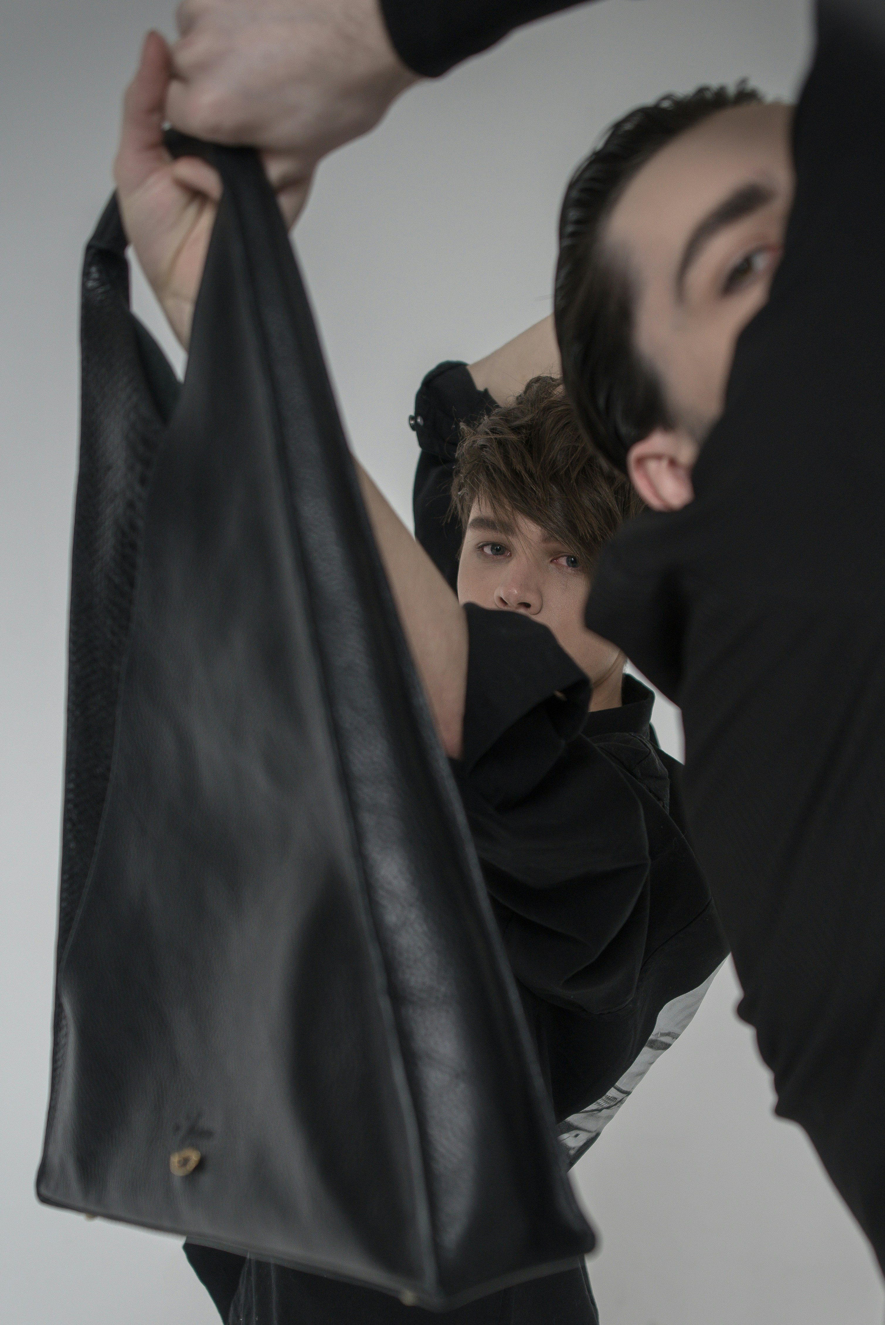 A man holding a black bag in front of his face photo – Free Model ...