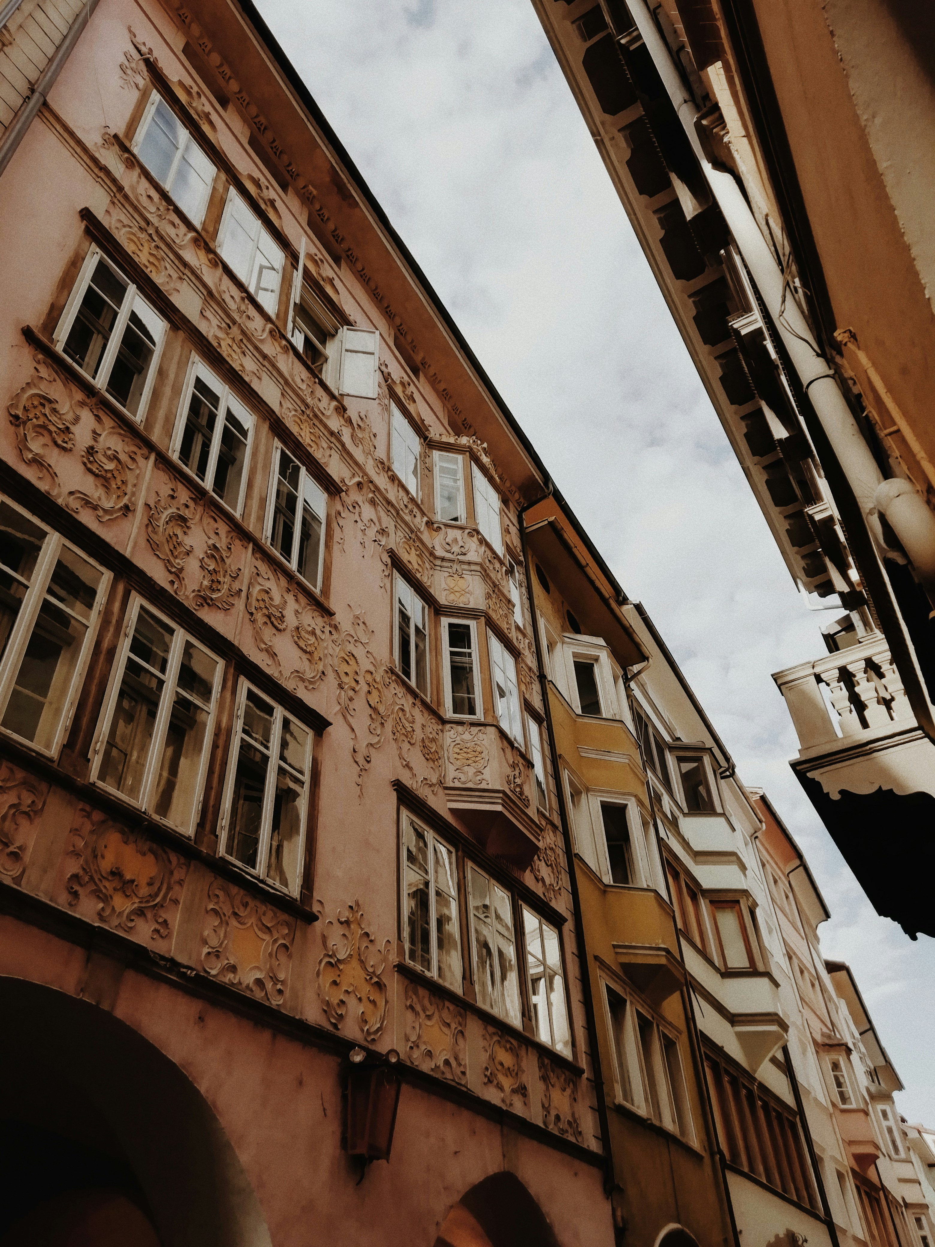 Ornate Facades Tilt Toward the Sky in a Narrow Alley
