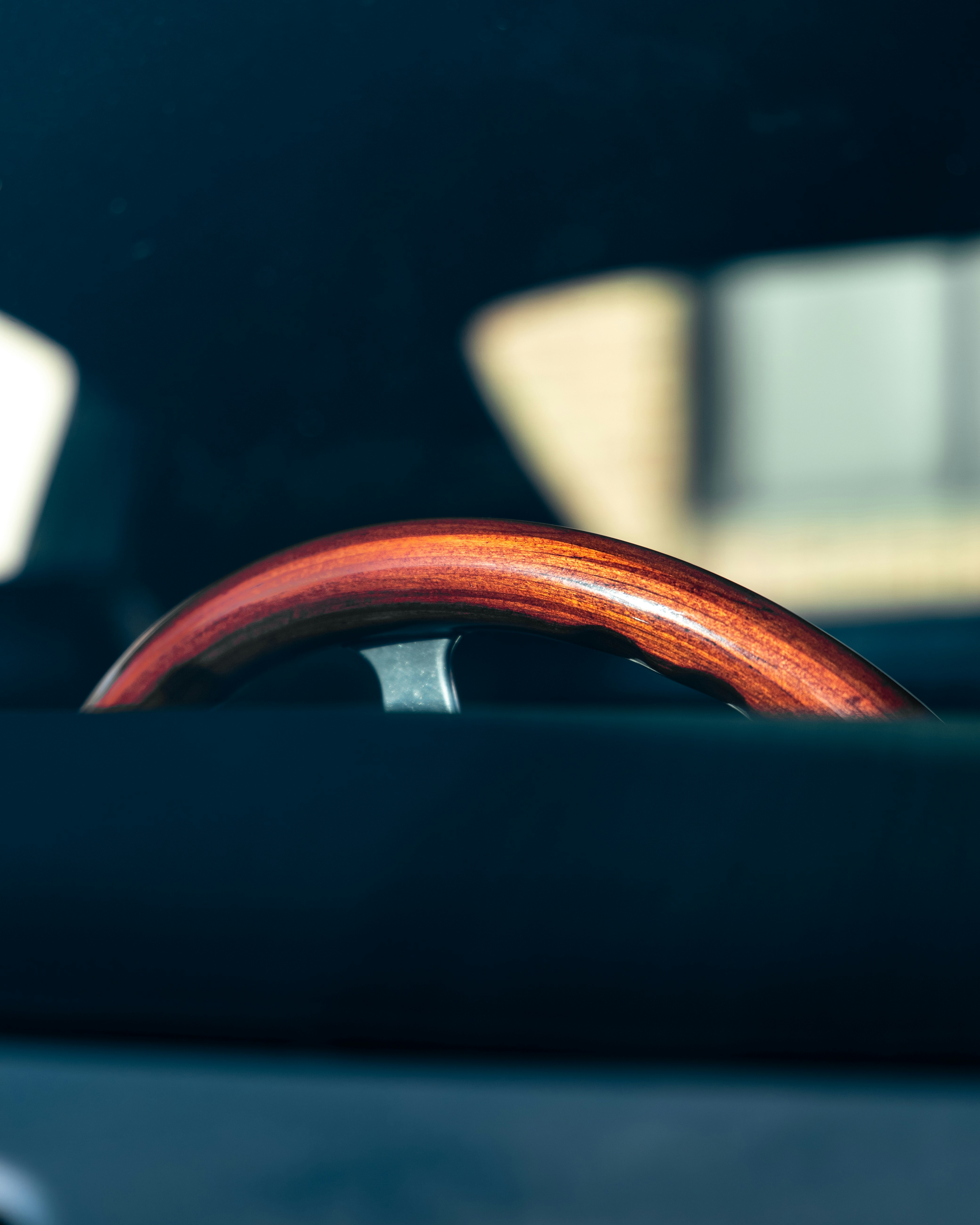 Warm Wood Grain Steers the Moment in a Dim Car Cabin