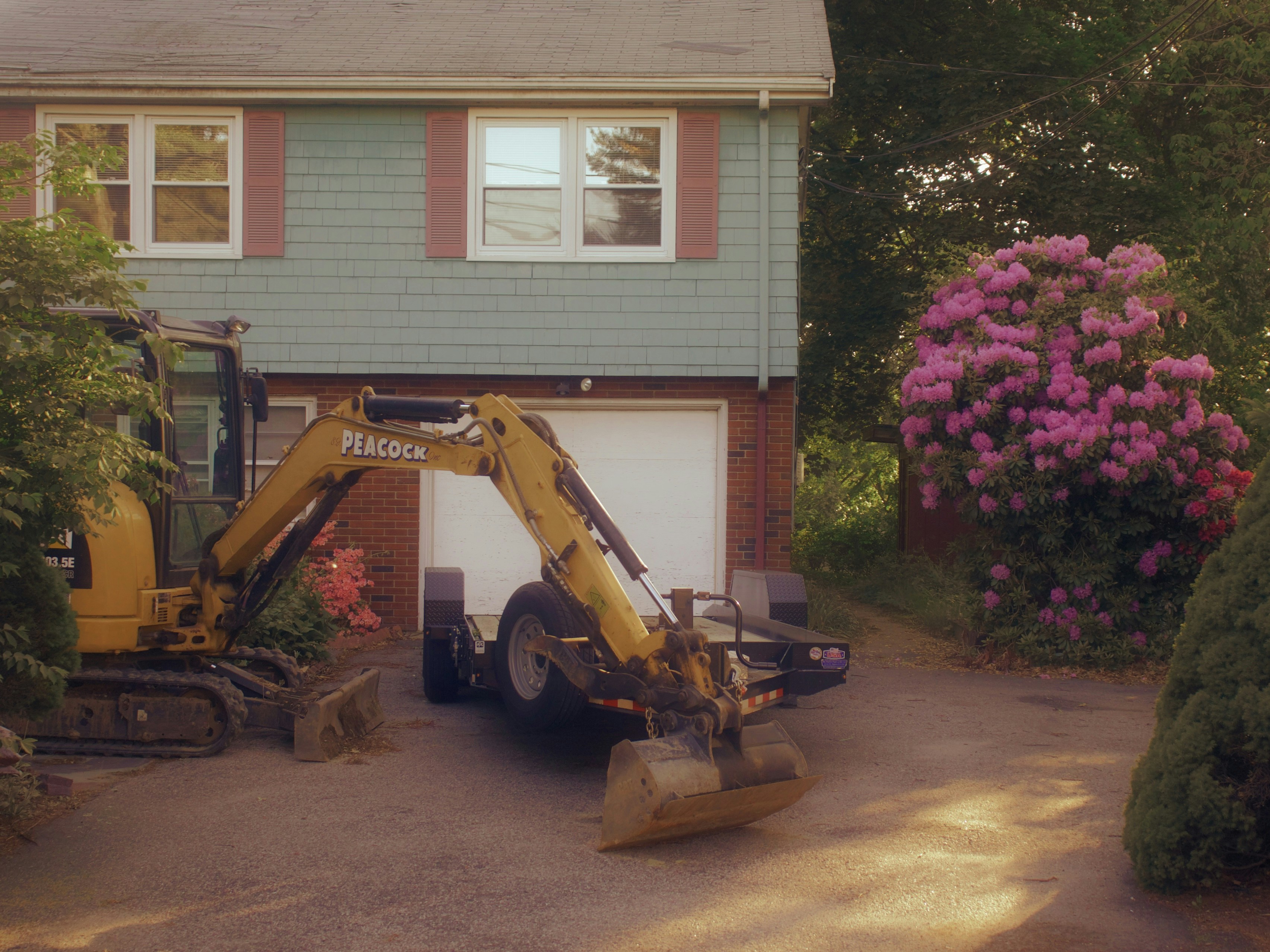 A yellow bulldozer is parked in front of a house photo – Free Vehicle ...