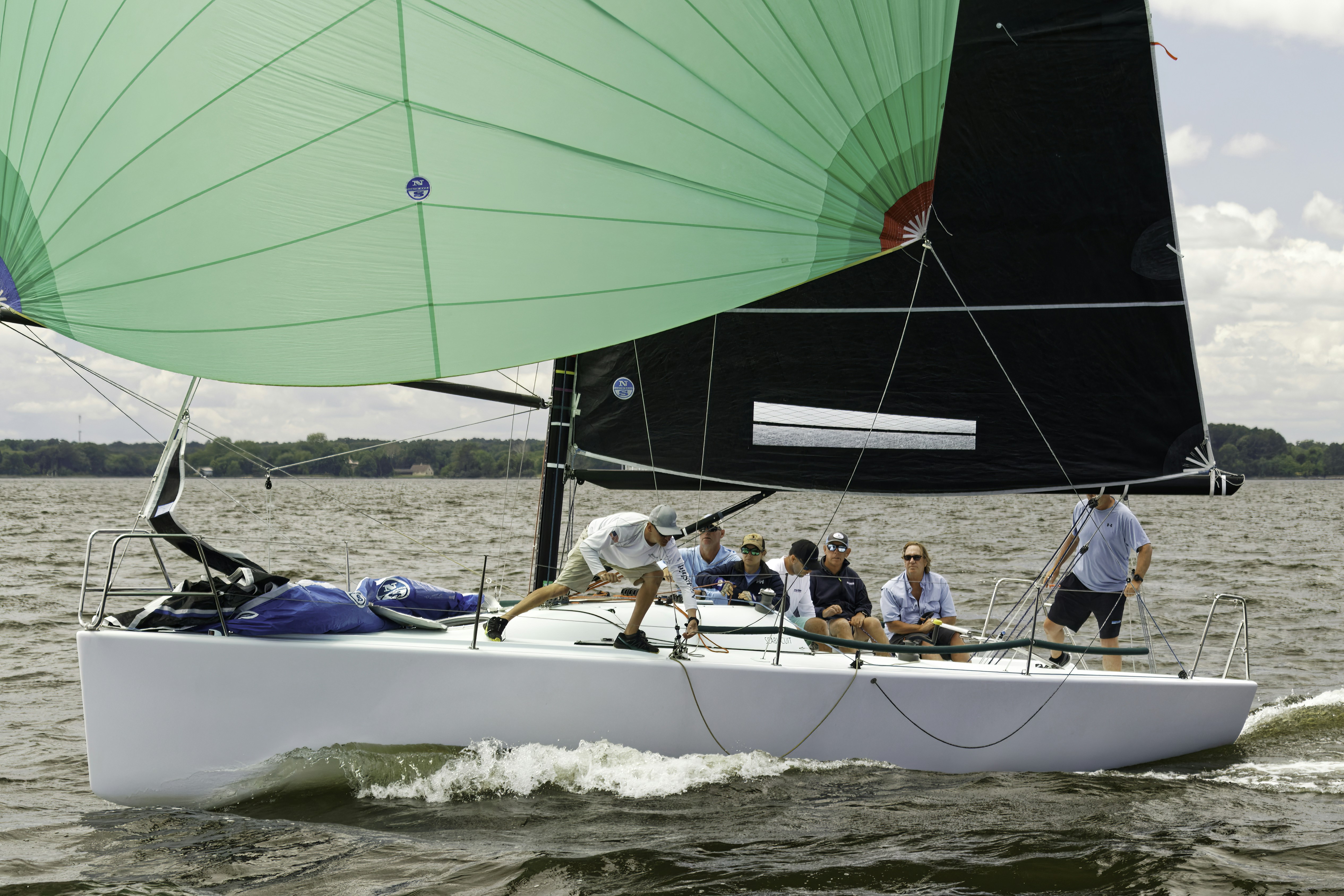 A group of people riding on the back of a sailboat photo – Free St ...
