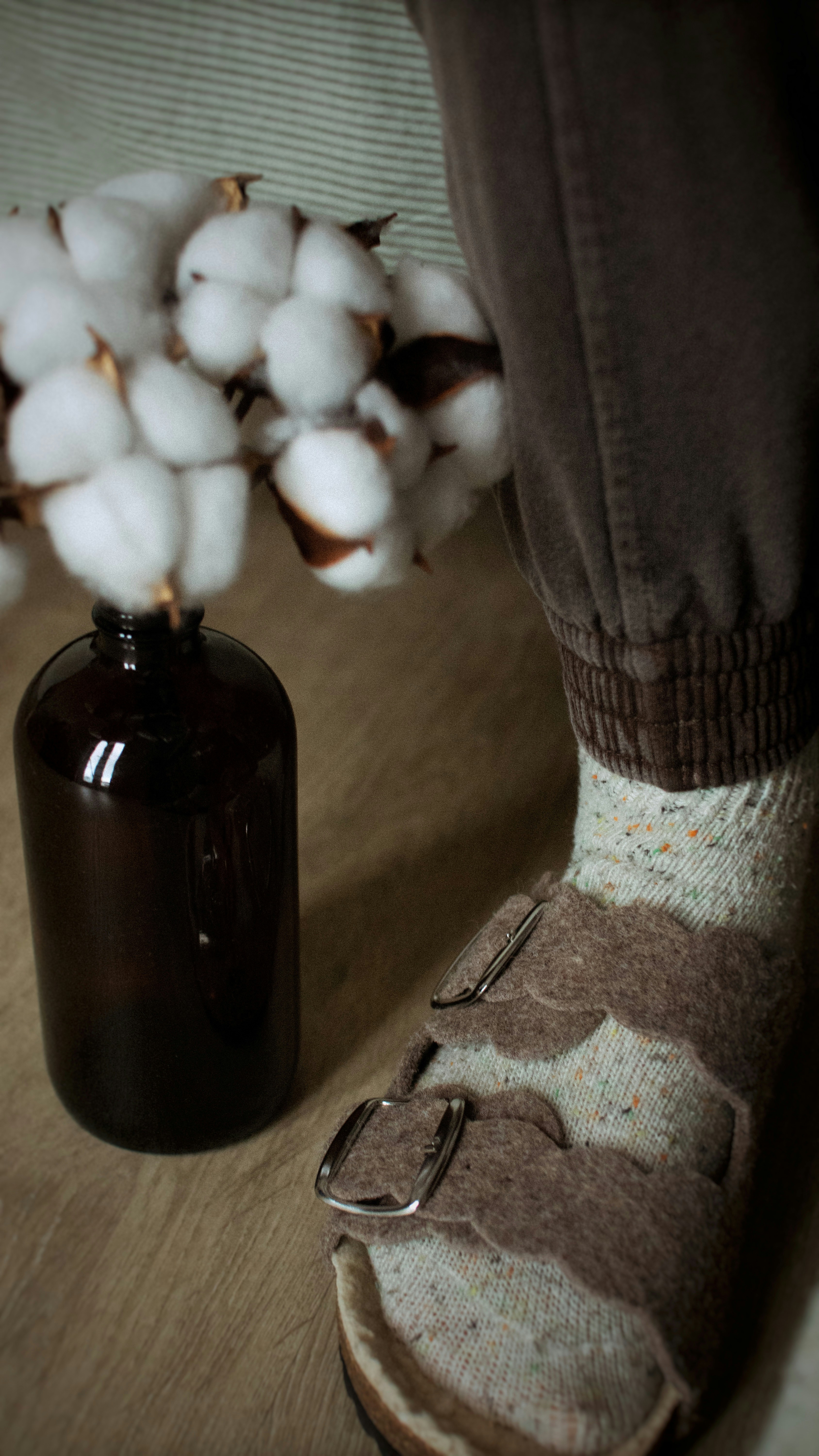 a person standing next to a bottle of cotton