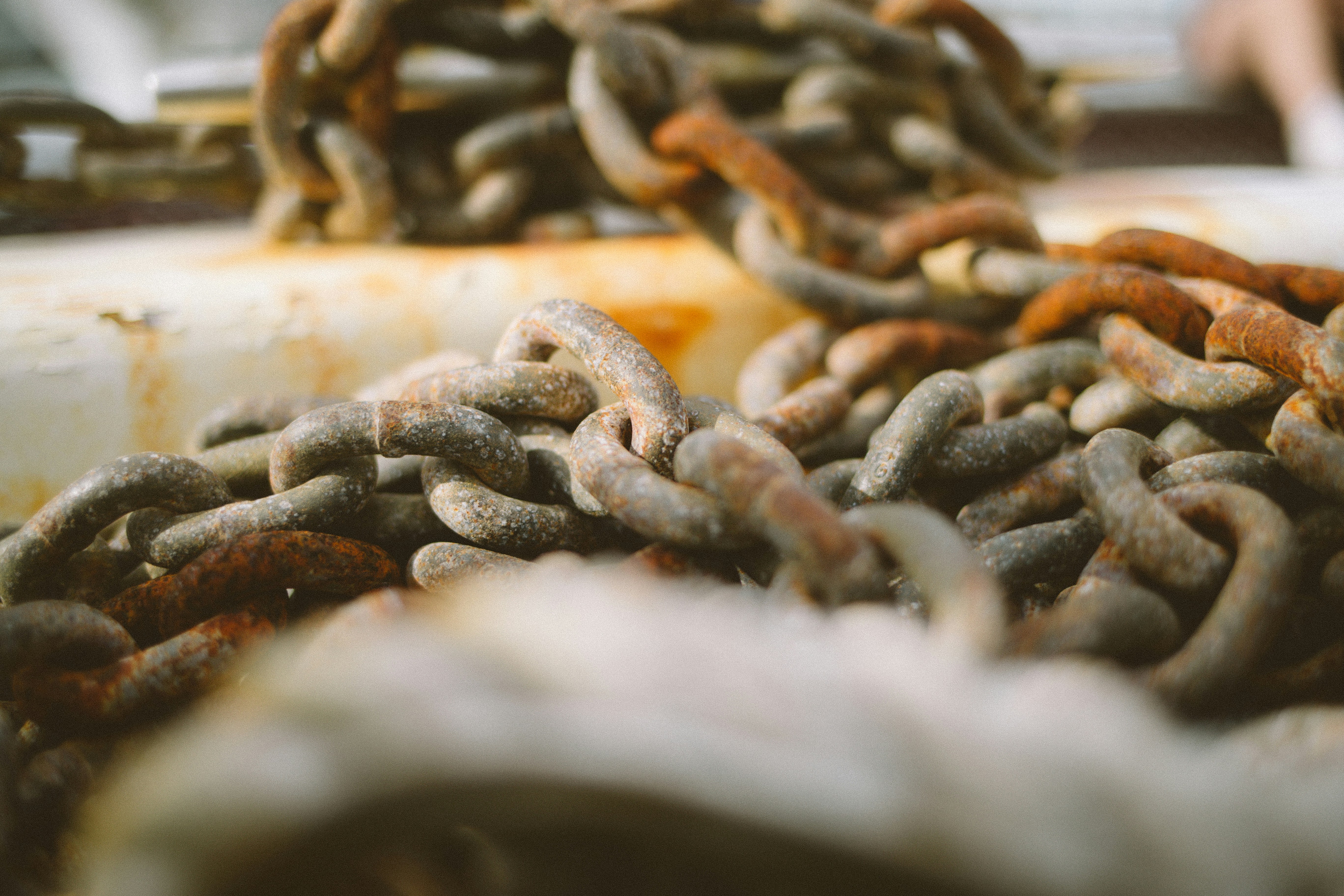 A pile of rusty chains sitting on top of a table photo – Free Boat ...