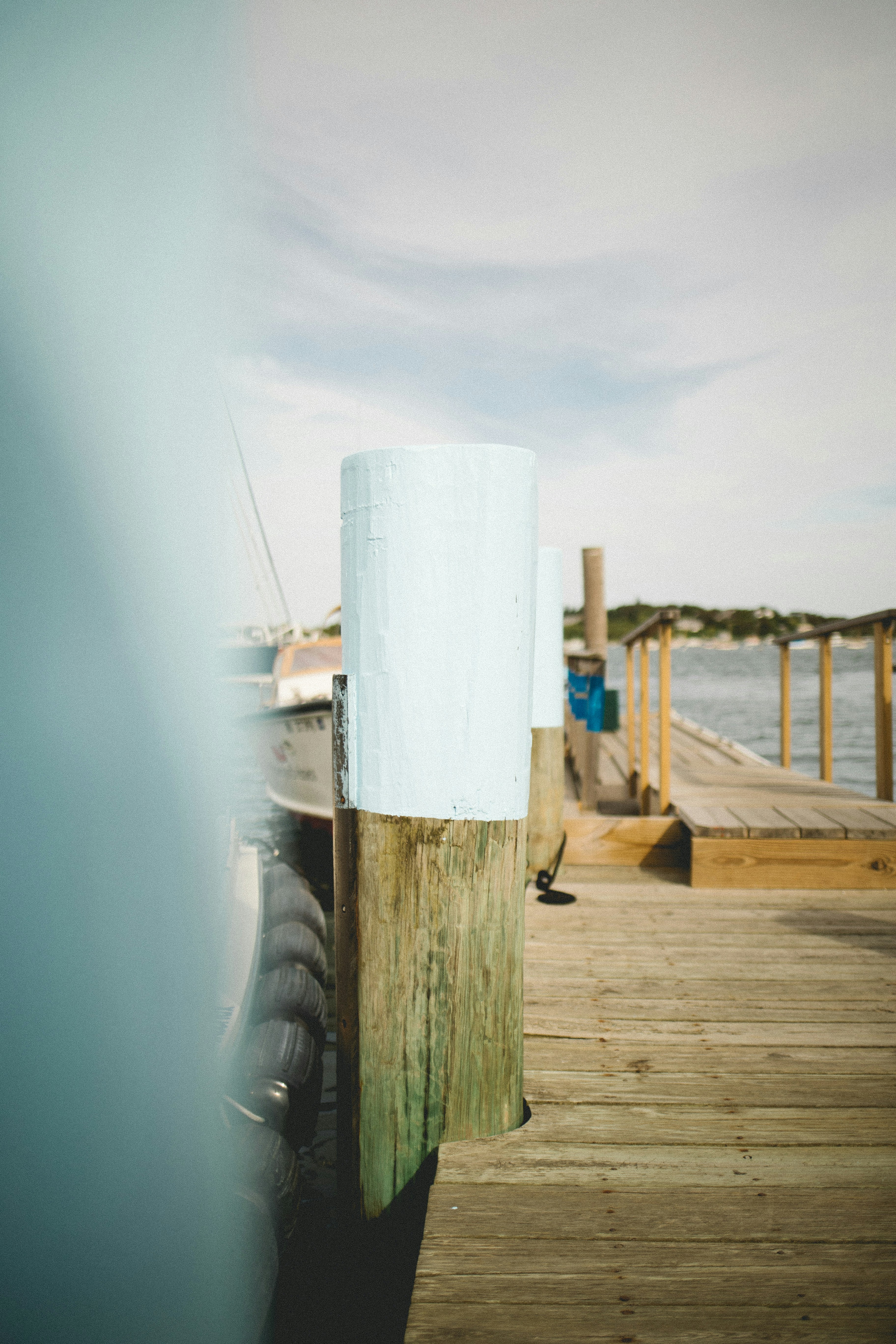 Pale-Blue Bollard at the Edge of a Quiet Marina Dock